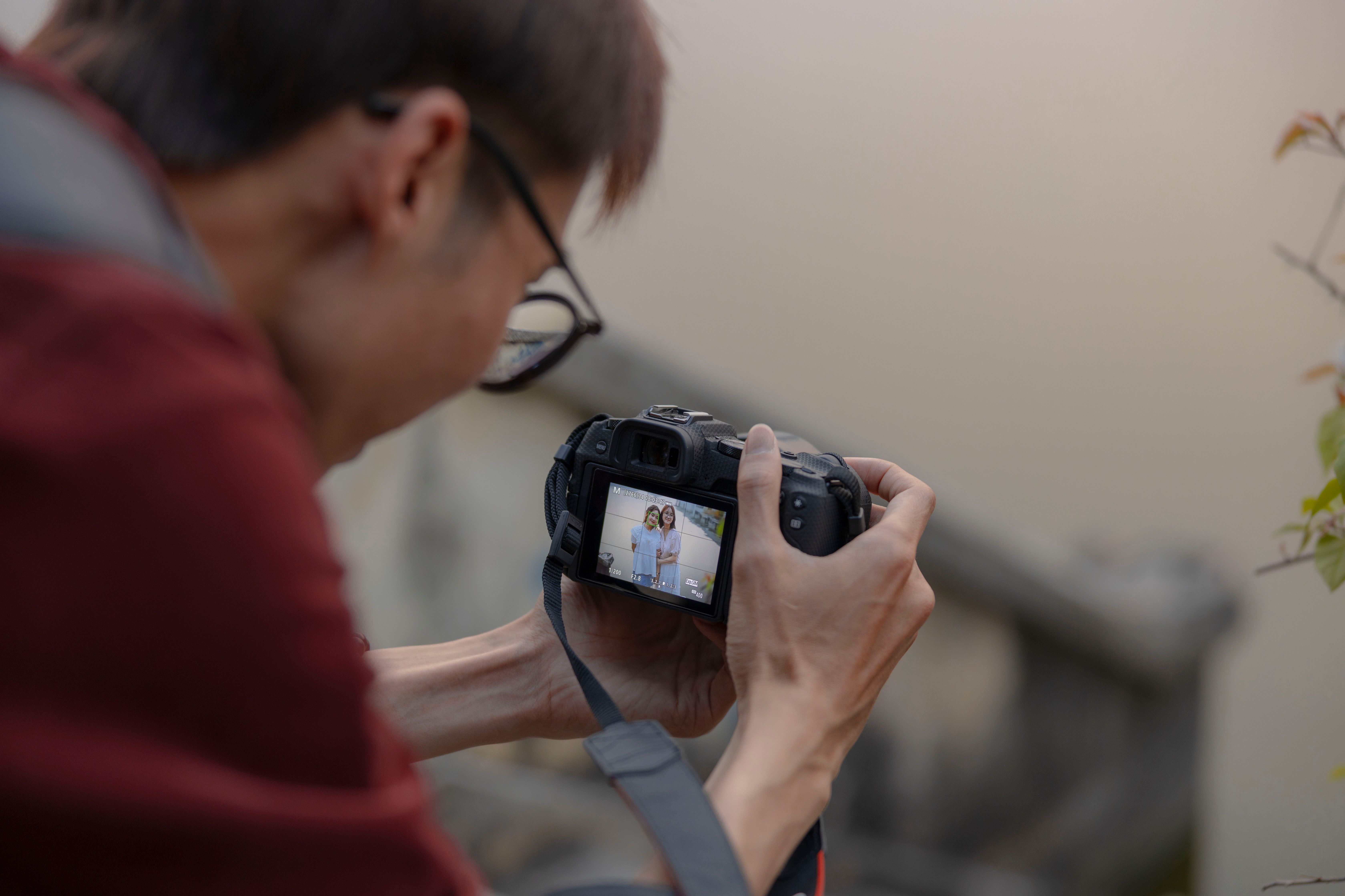 A man taking a picture of a camera · Free Stock Photo
