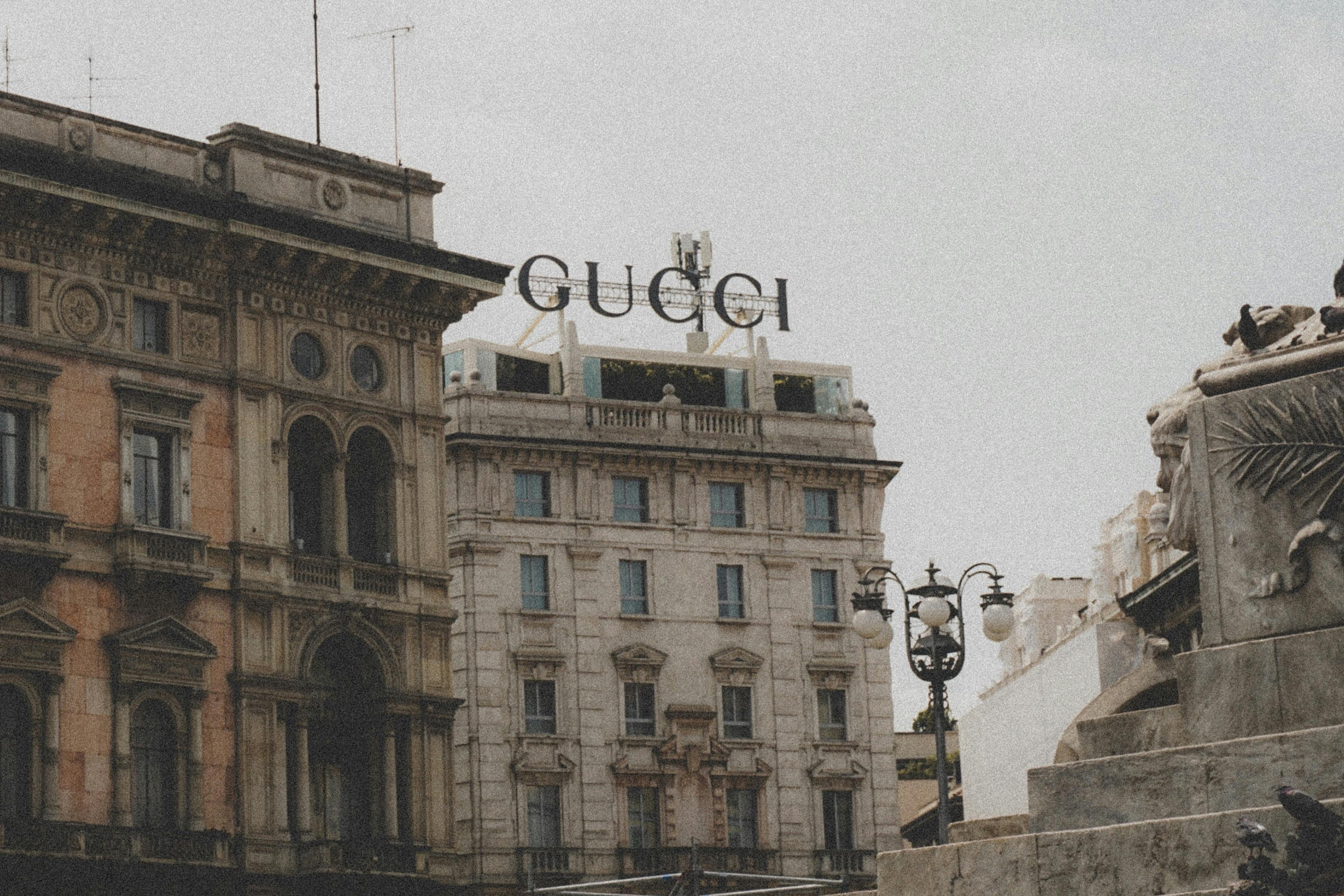 Gucci Logo over Buildings in City · Free Stock Photo