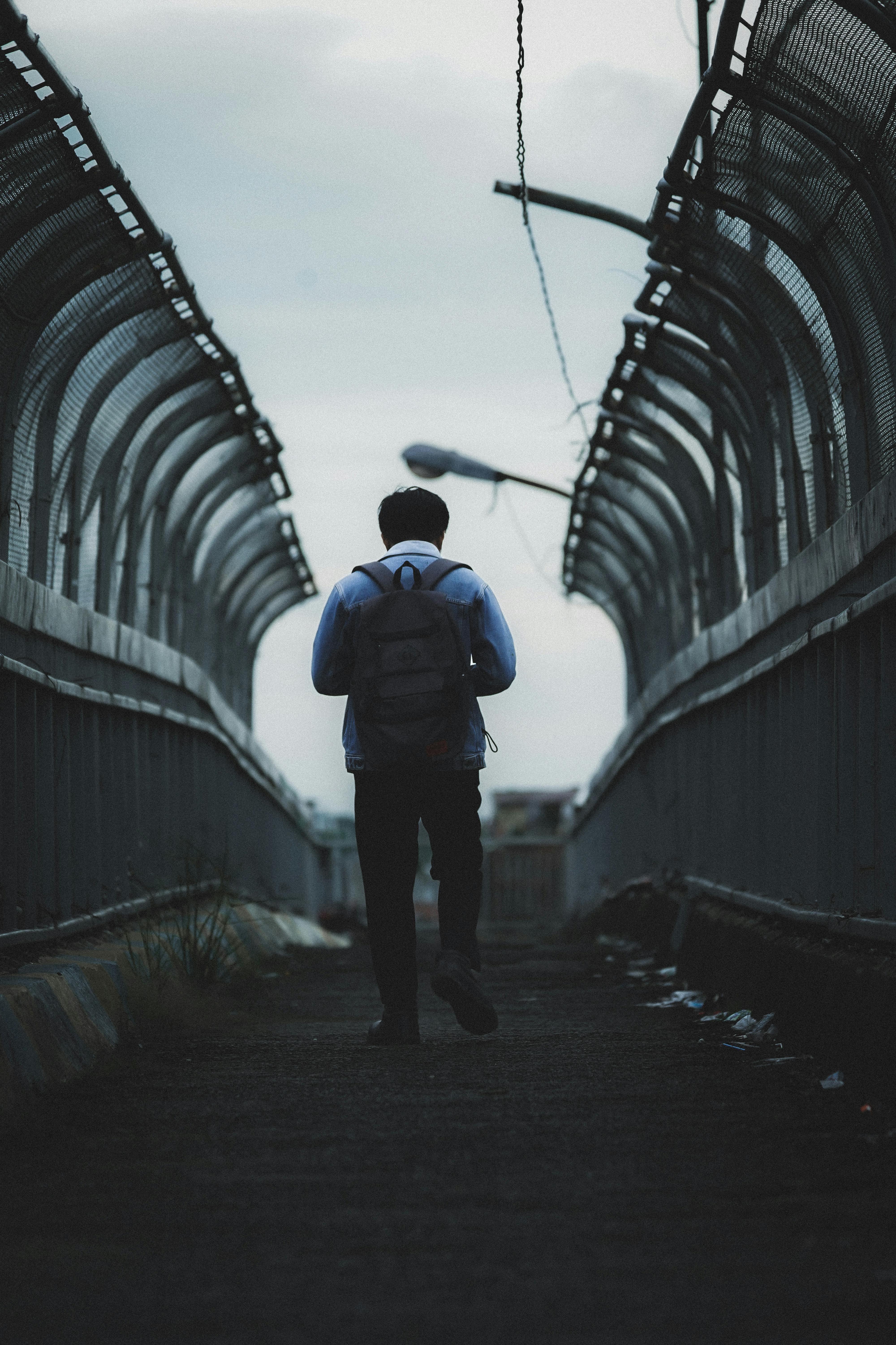 Man with Backpack on Footbridge · Free Stock Photo