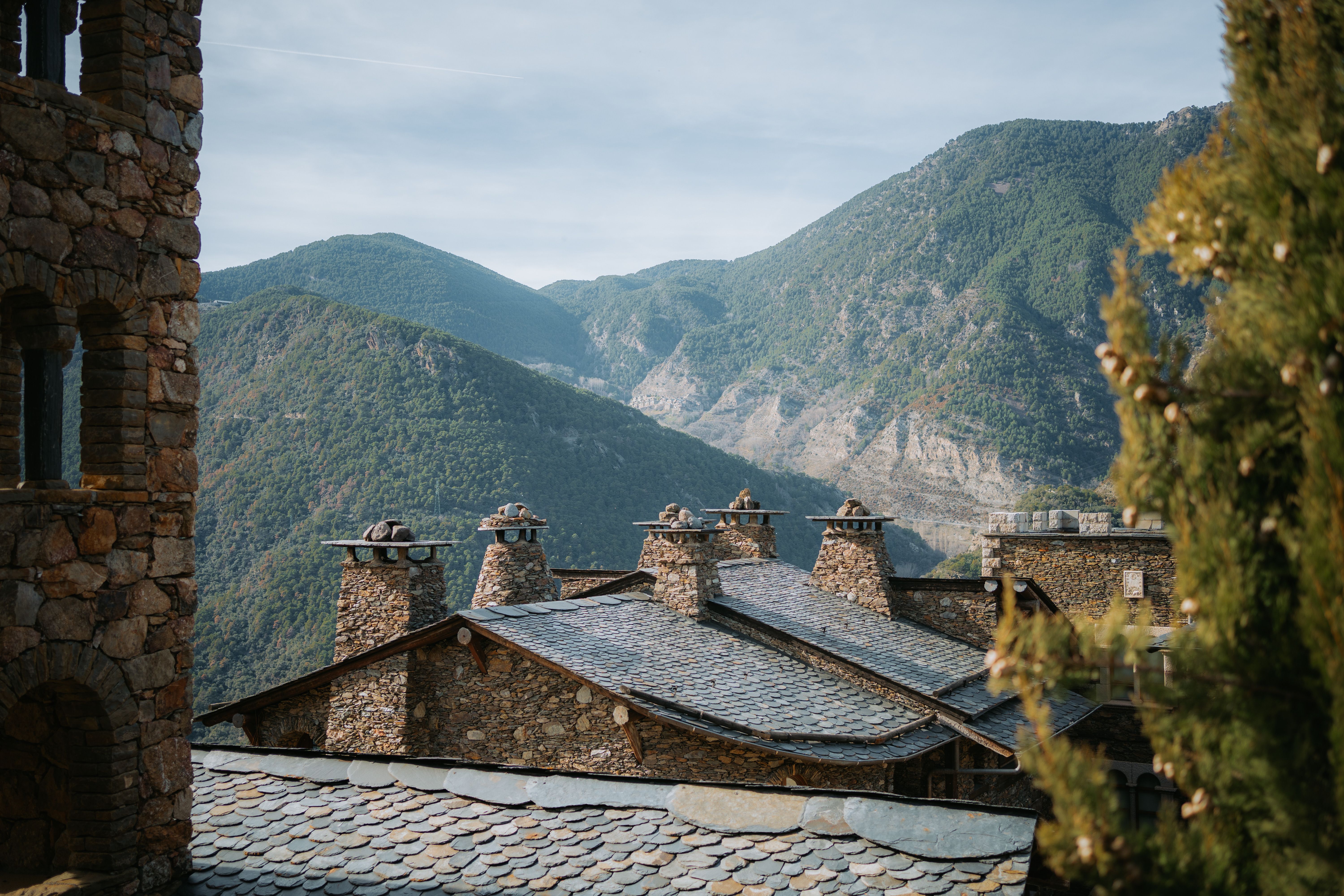 Mountains Above the Rooftops of Medieval Stone Buildings · Free Stock Photo
