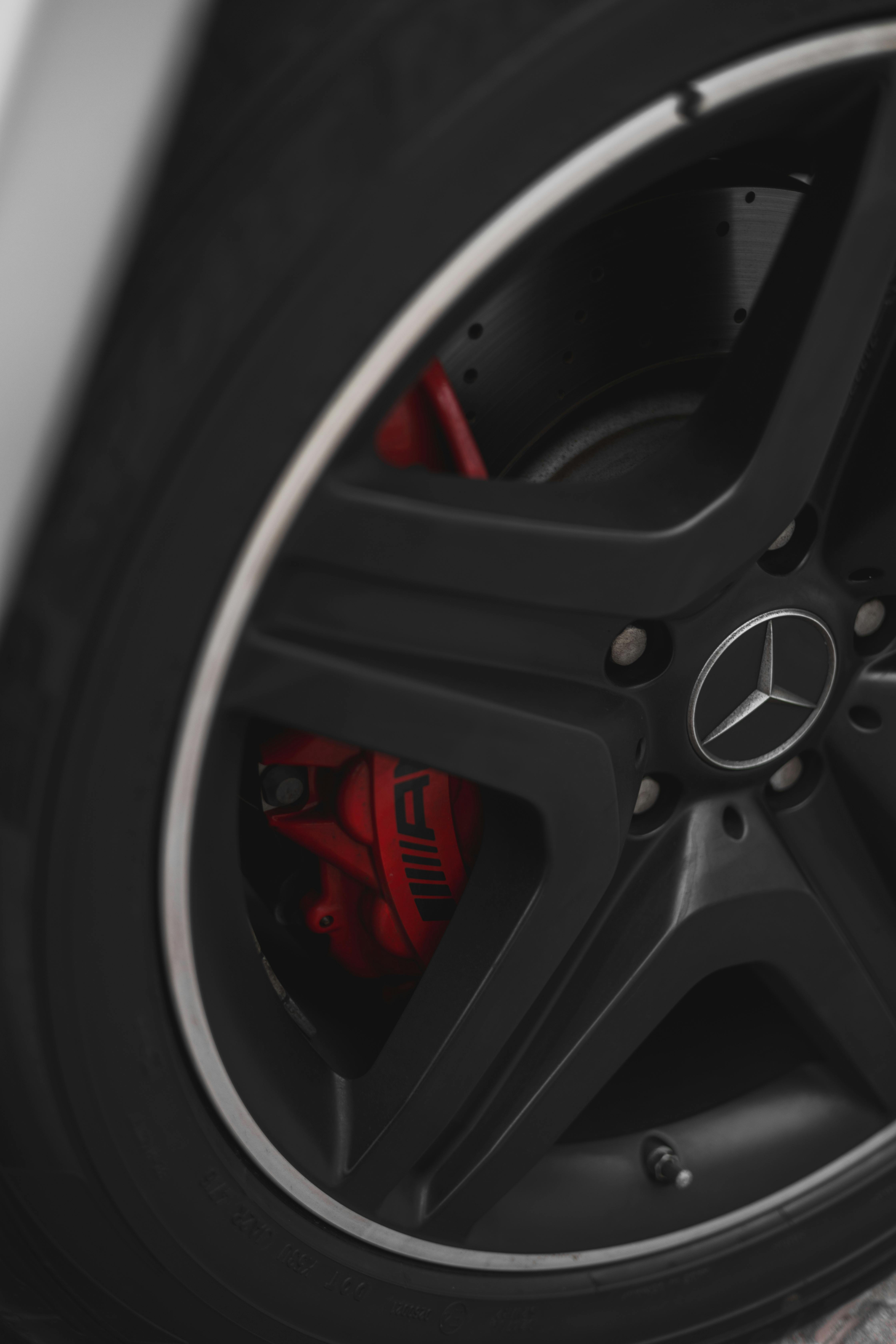 The front wheel of a mercedes benz car with red brake calipers · Free ...