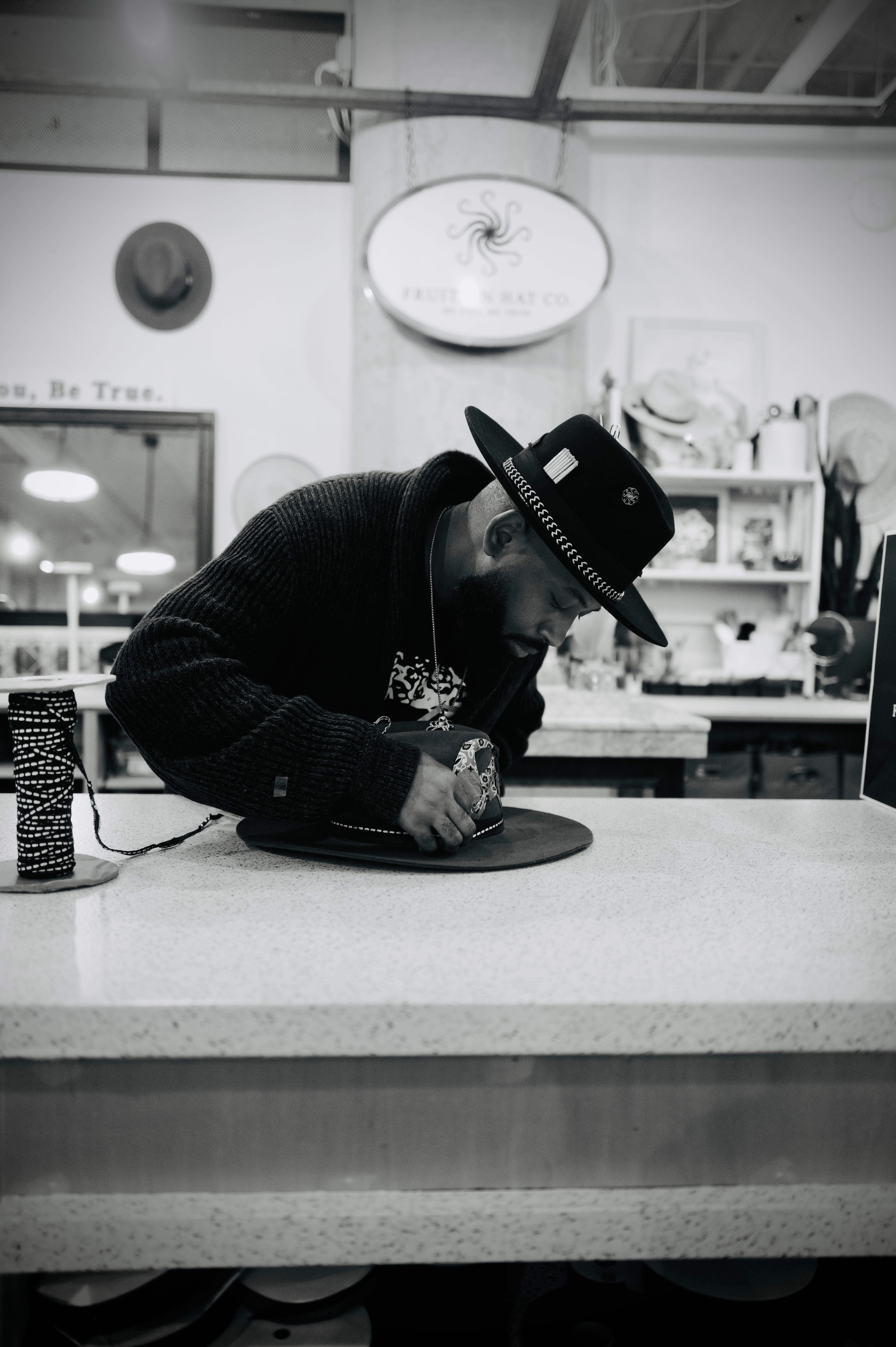 Man Designing Hats in a Shop · Free Stock Photo