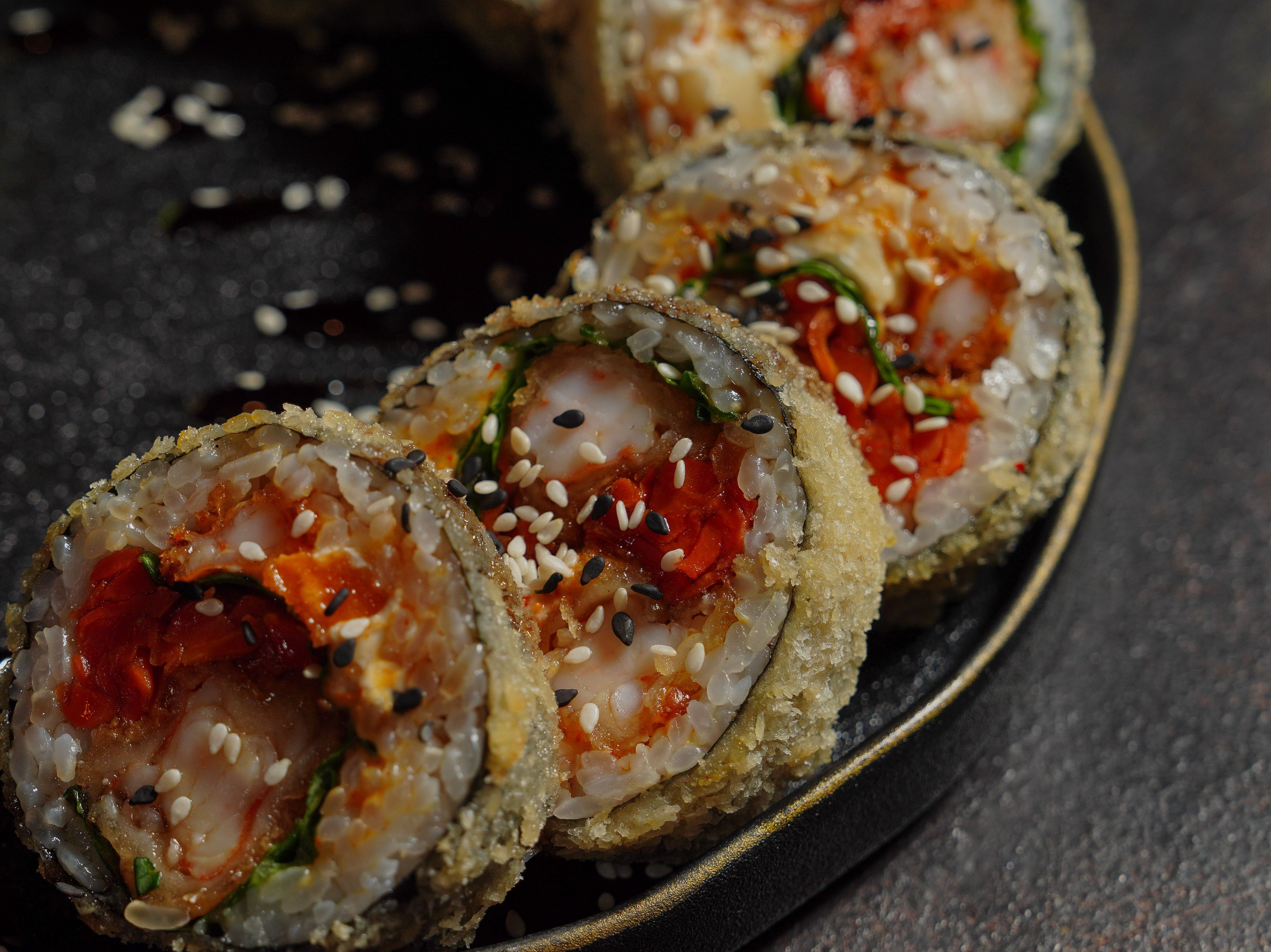 A plate of sushi with sesame seeds and red pepper · Free Stock Photo