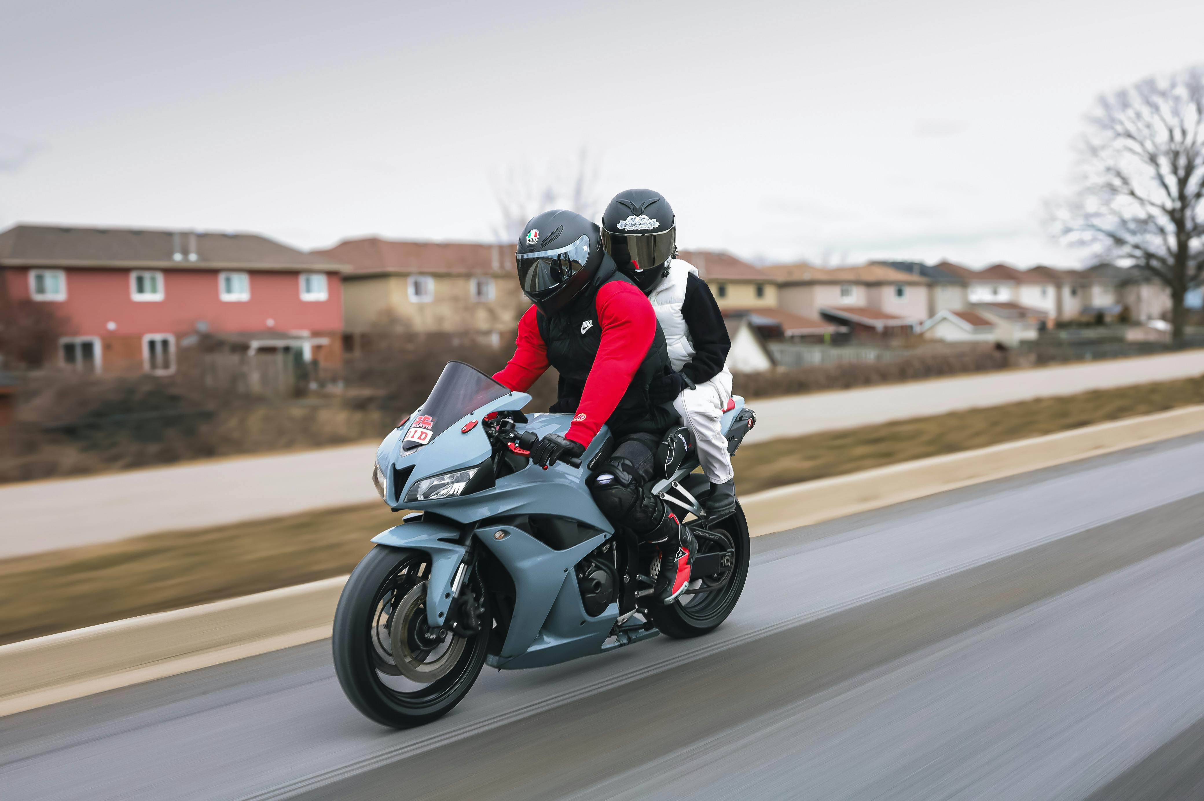 Two People Riding a Motorcycle · Free Stock Photo