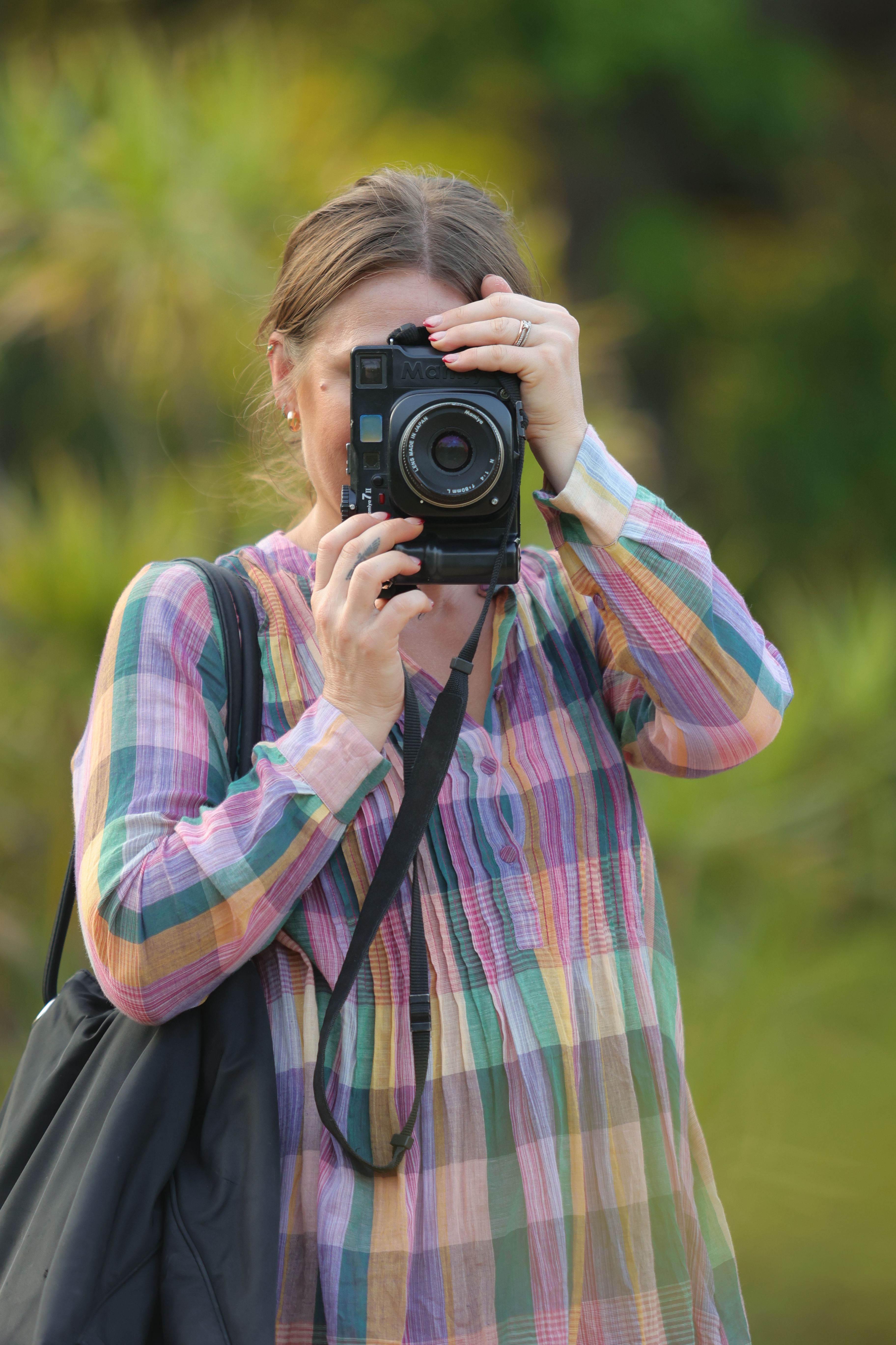 A woman taking a picture with her camera · Free Stock Photo