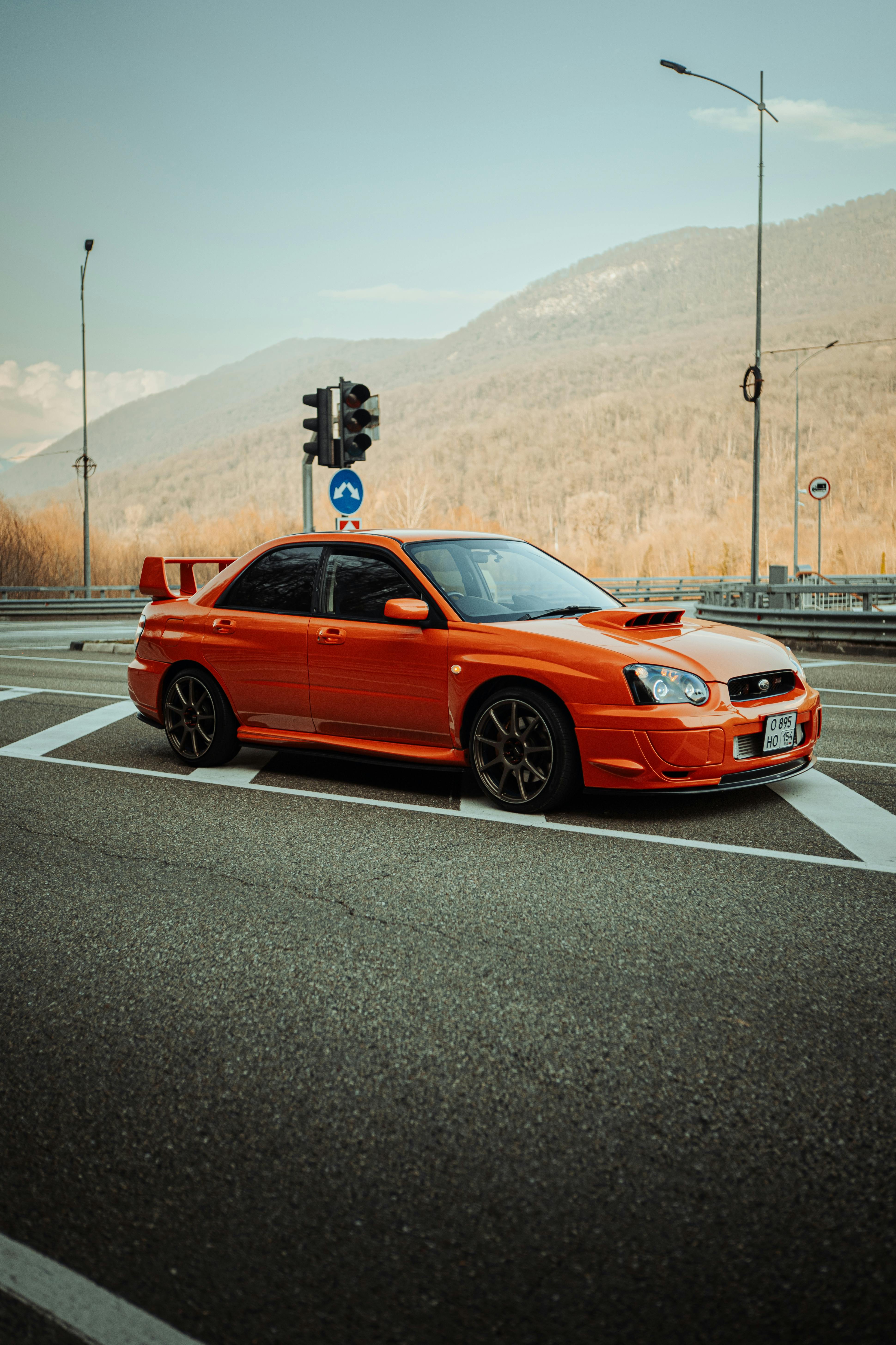 A Red Subaru Impreza on a Street · Free Stock Photo
