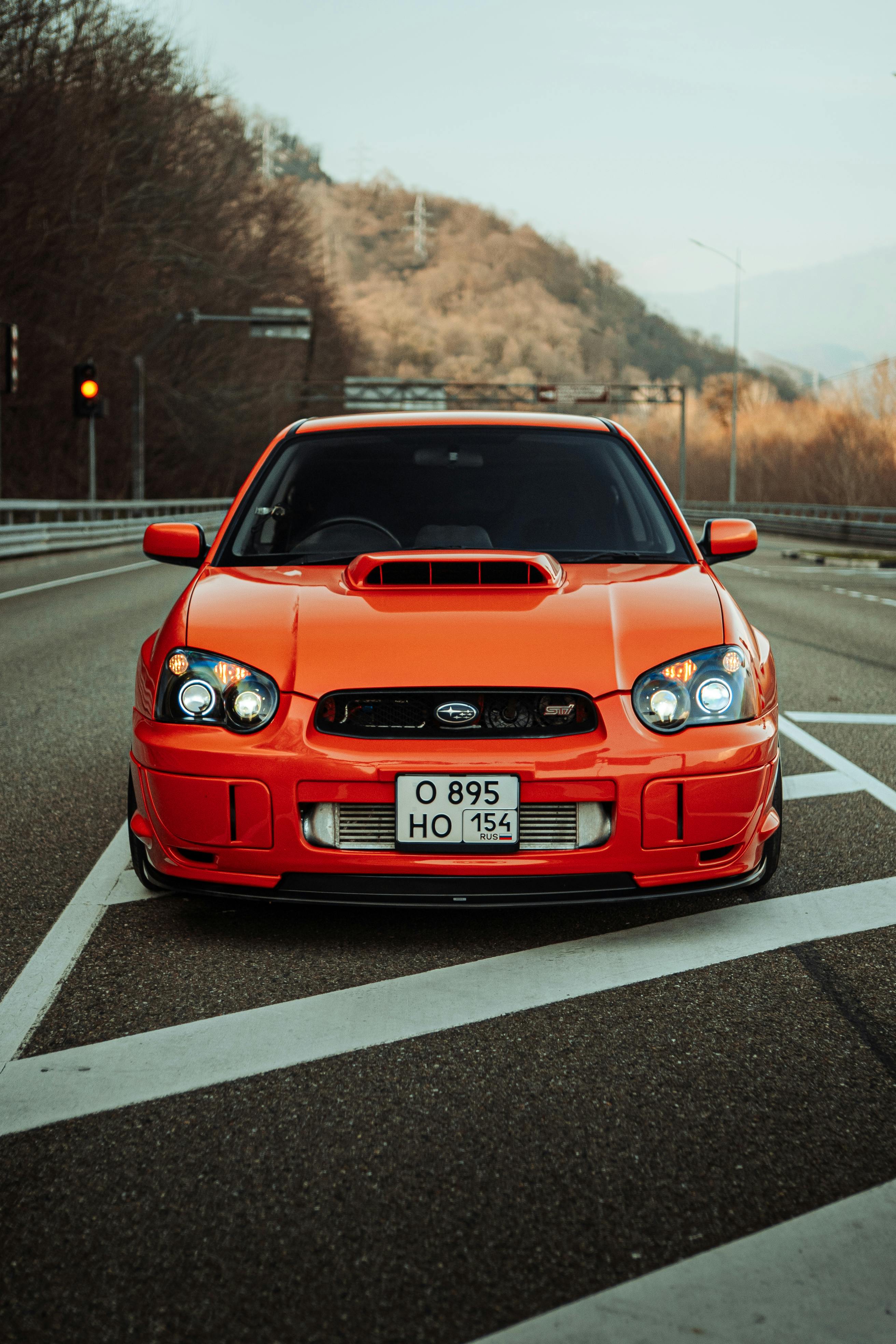 A Red Subaru Impreza on a Street · Free Stock Photo