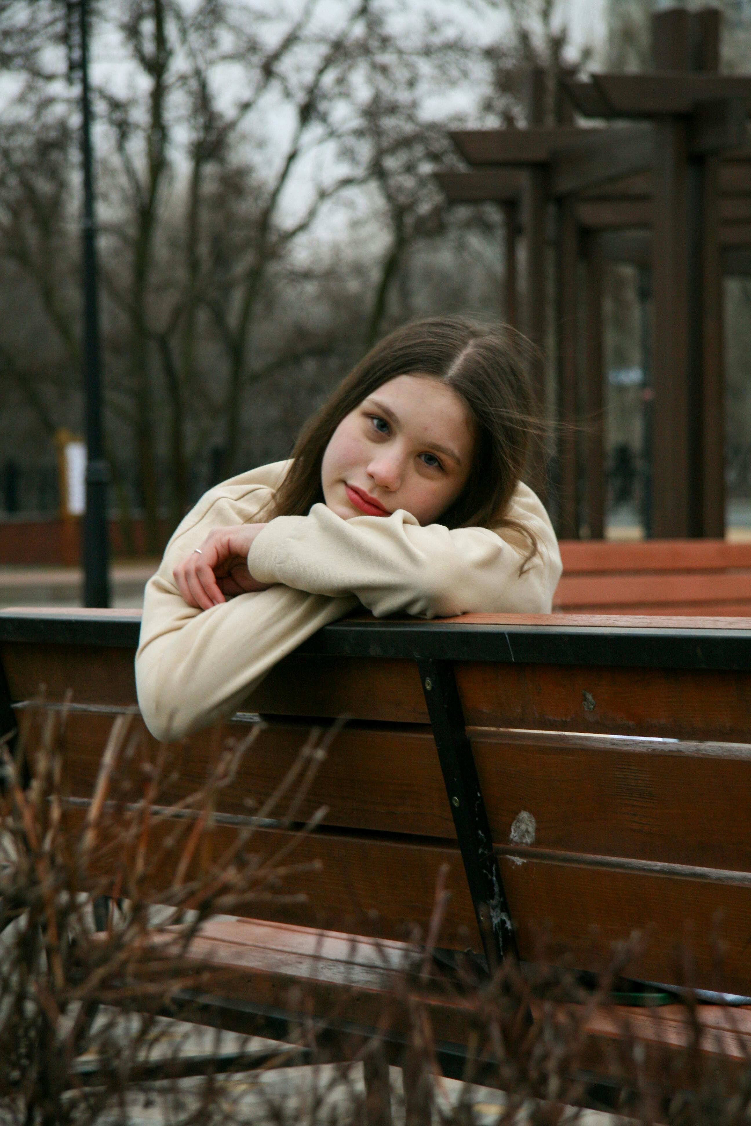 Woman Leaning on Bench at Park · Free Stock Photo