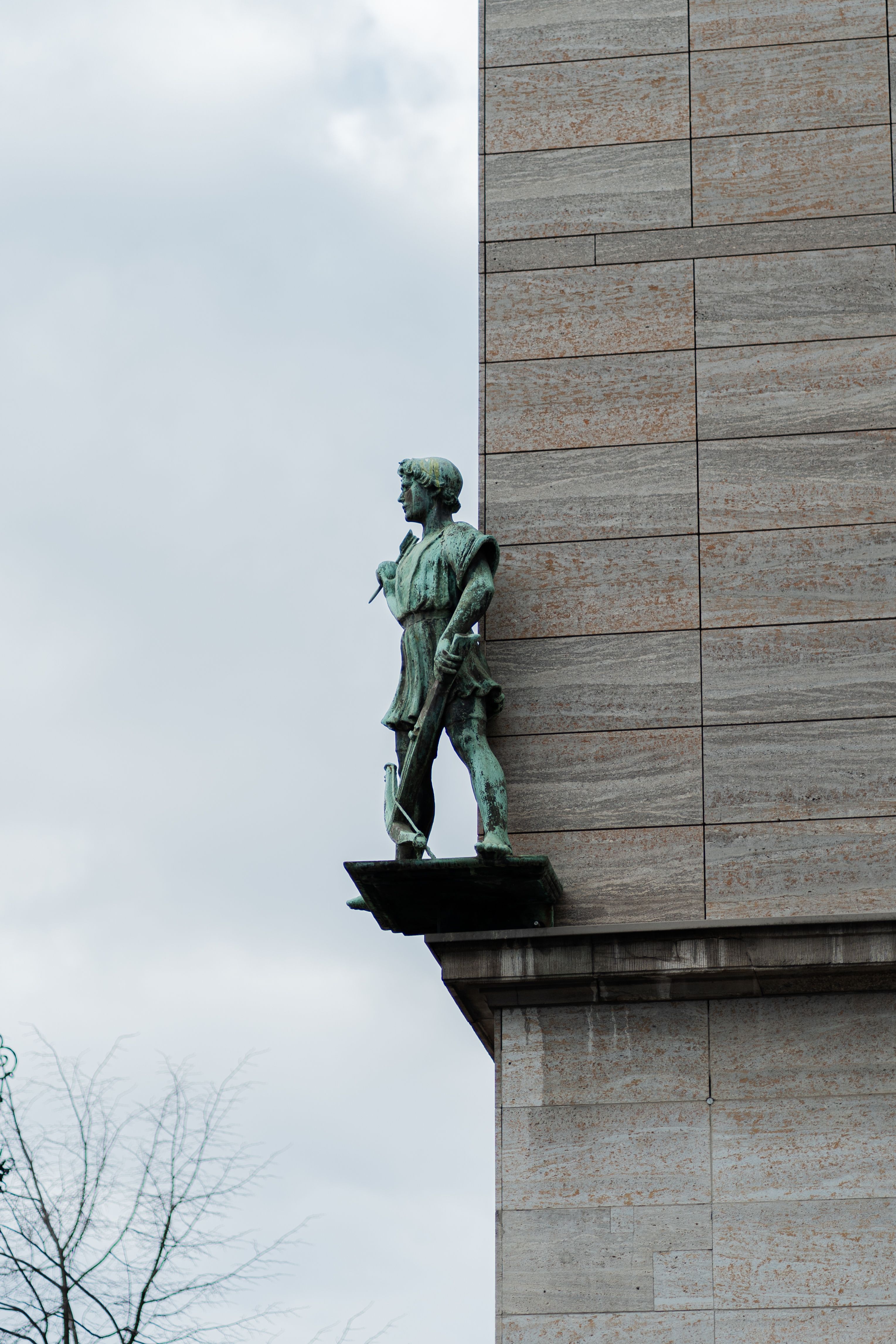 A statue of a man on top of a building · Free Stock Photo
