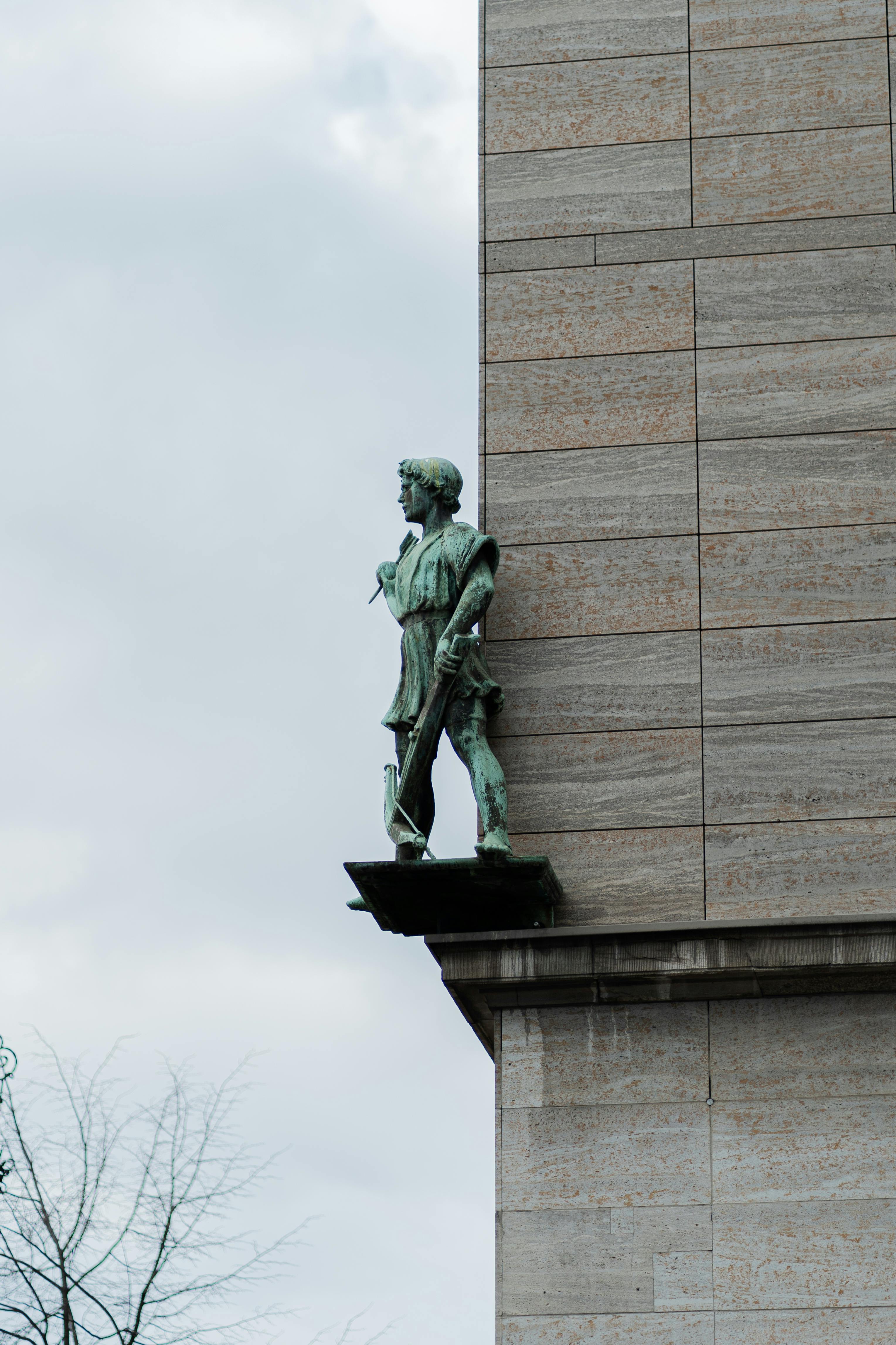 Statue of Standing Boy on Building Corner · Free Stock Photo