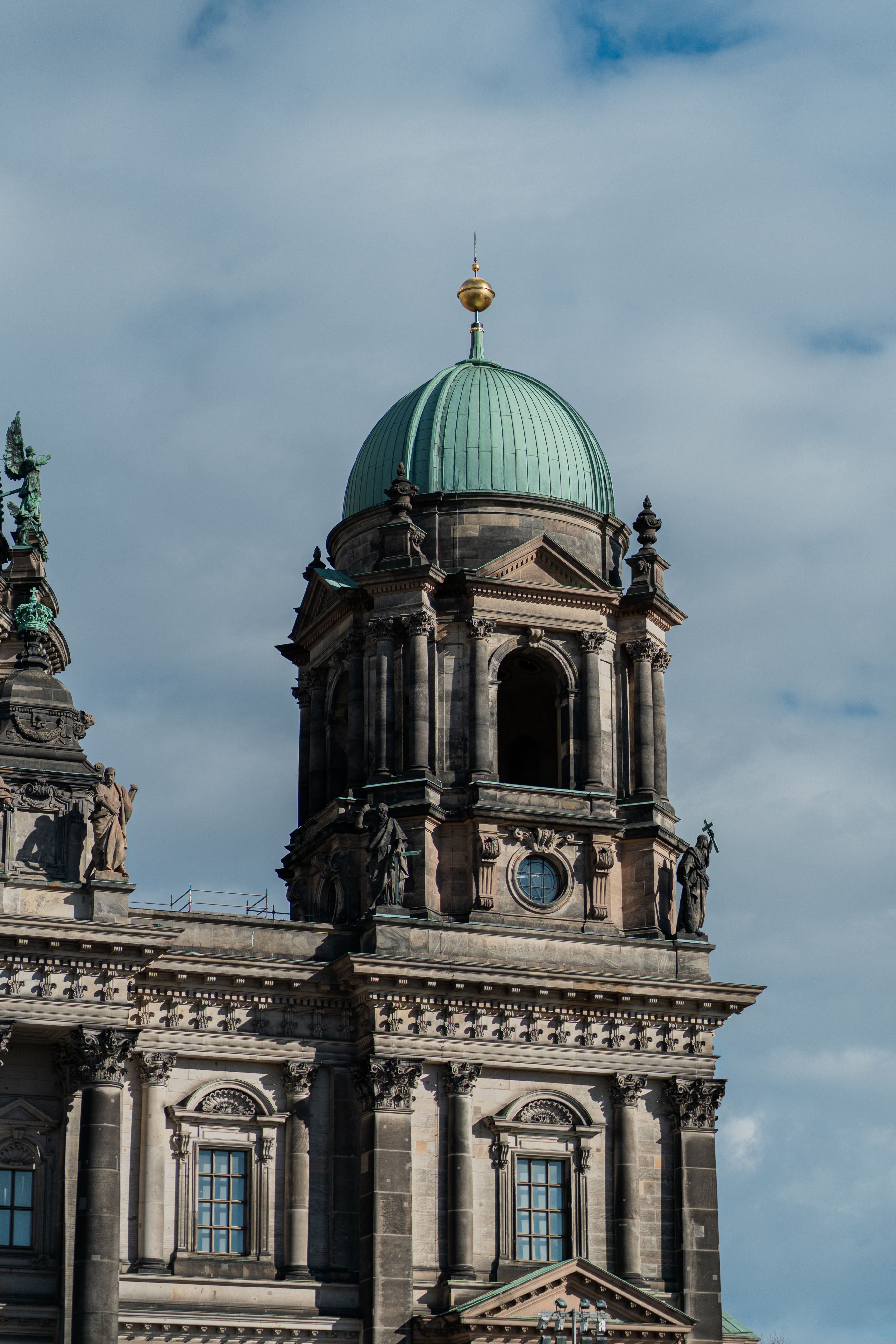 A large building with a dome and two green domes · Free Stock Photo