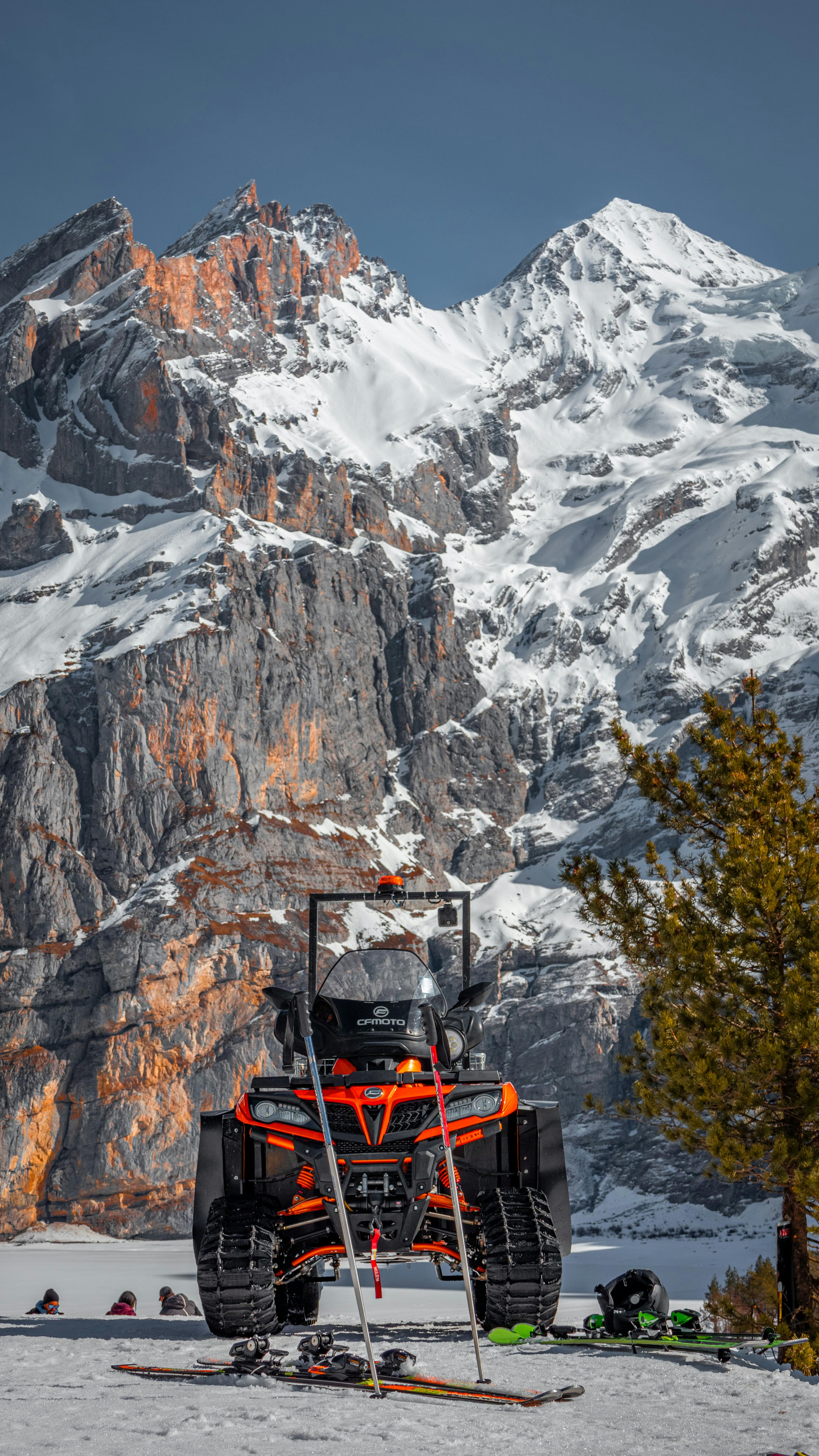 Emergency Snow Vehicle Parked next to Skis on a Slope · Free Stock Photo