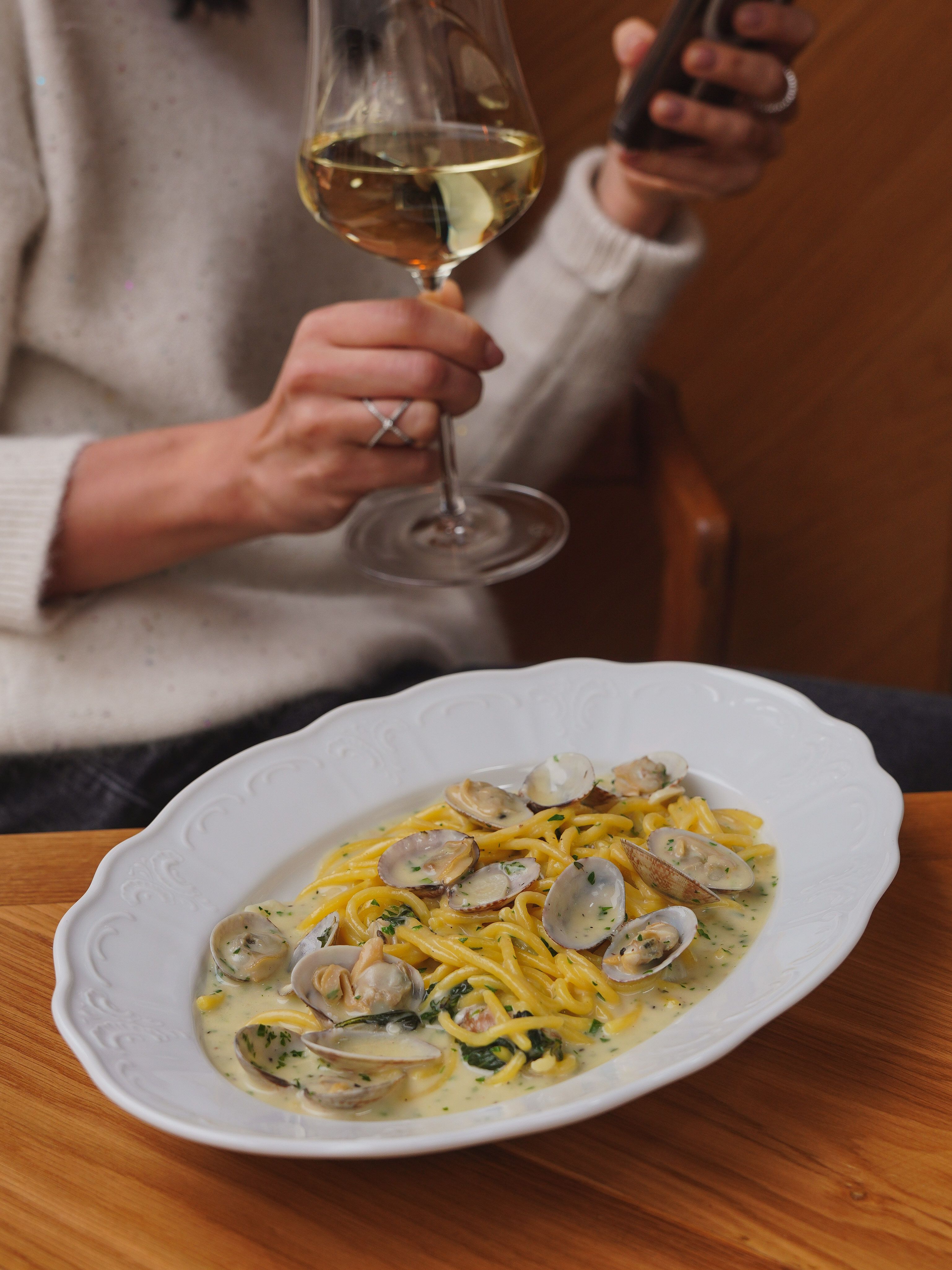 Elegant dining with seafood pasta and wine · Free Stock Photo