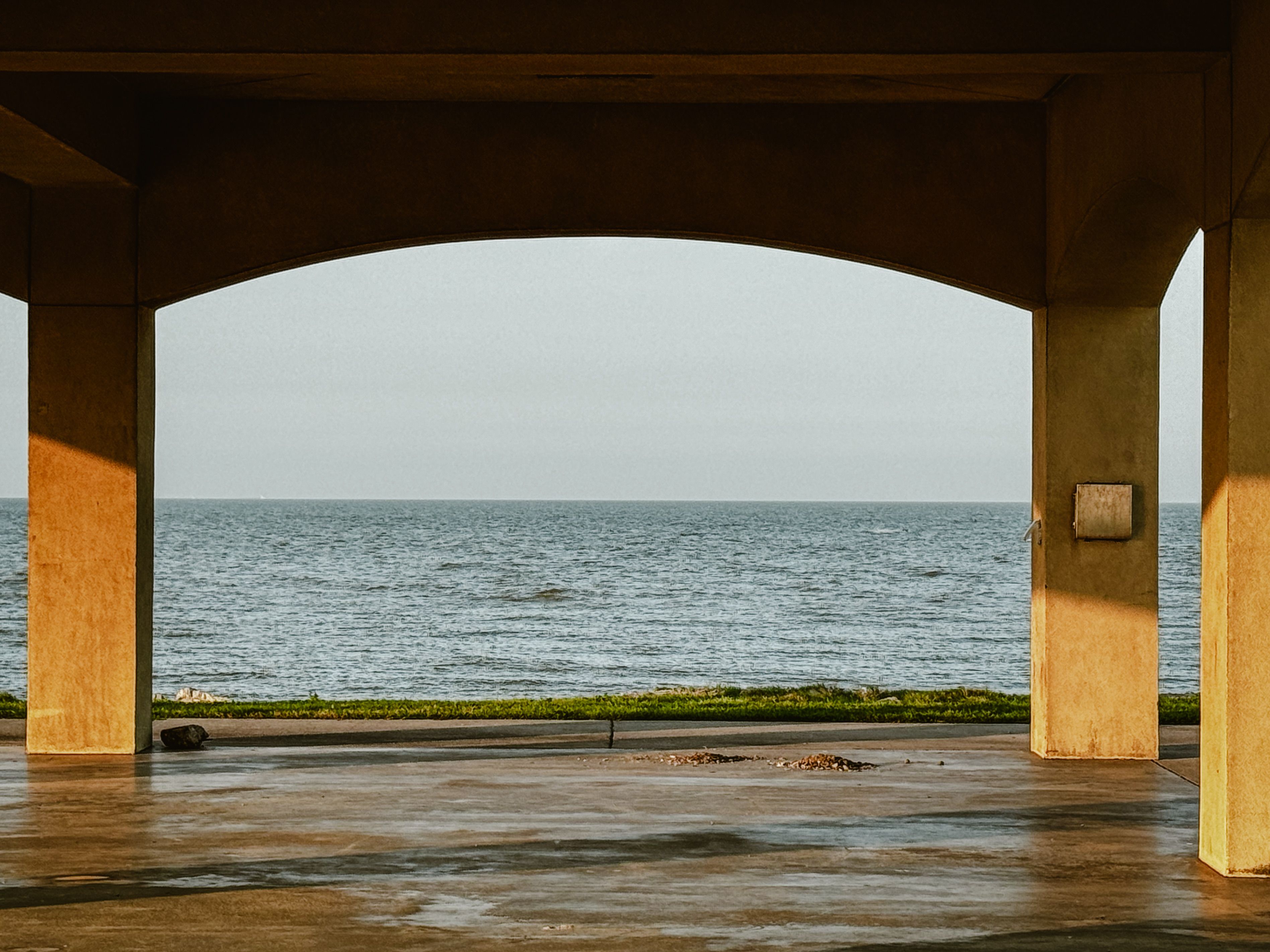 Building Pillars on Pavement on Sea Shore · Free Stock Photo