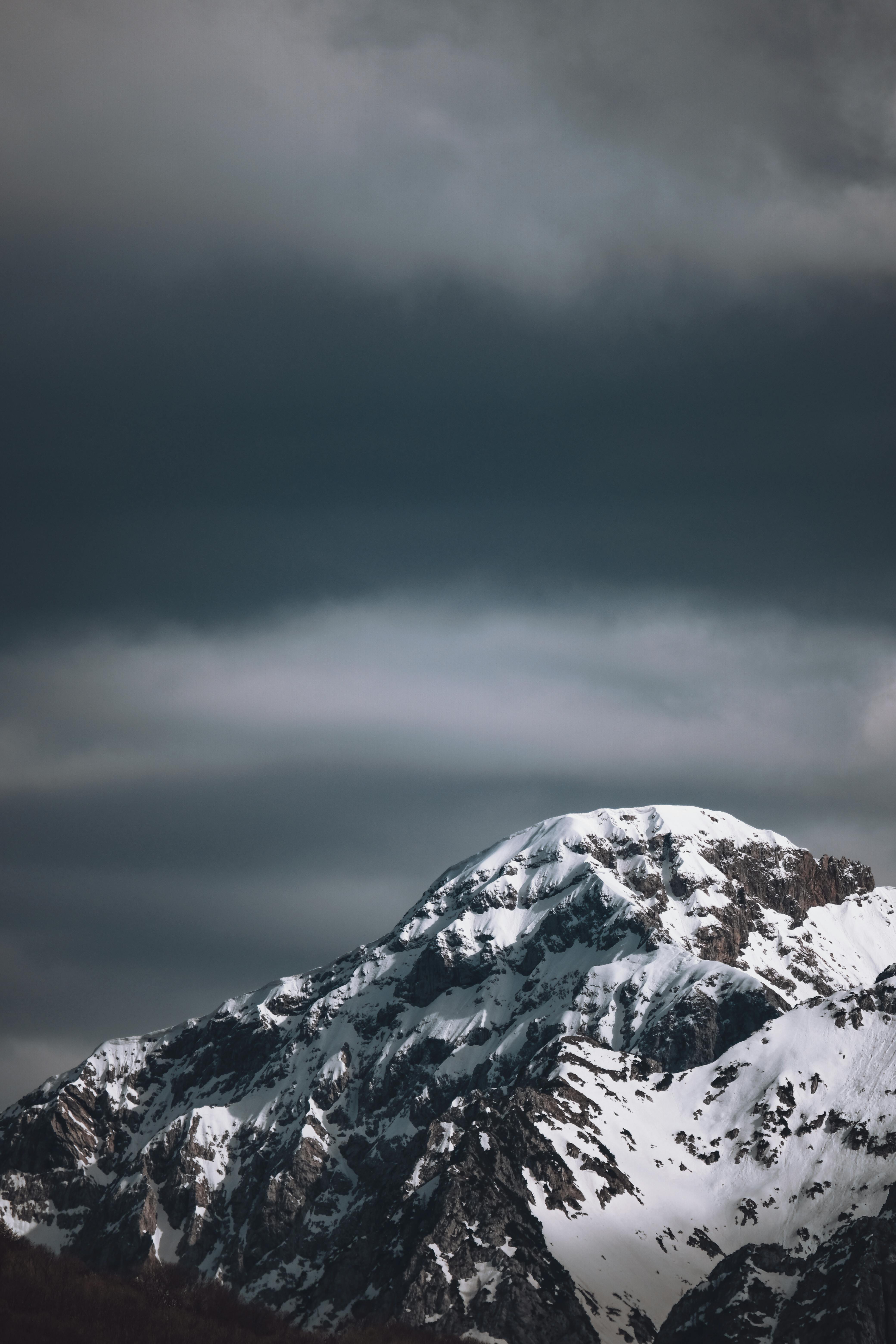 Storm Clouds over Mountain Peak · Free Stock Photo