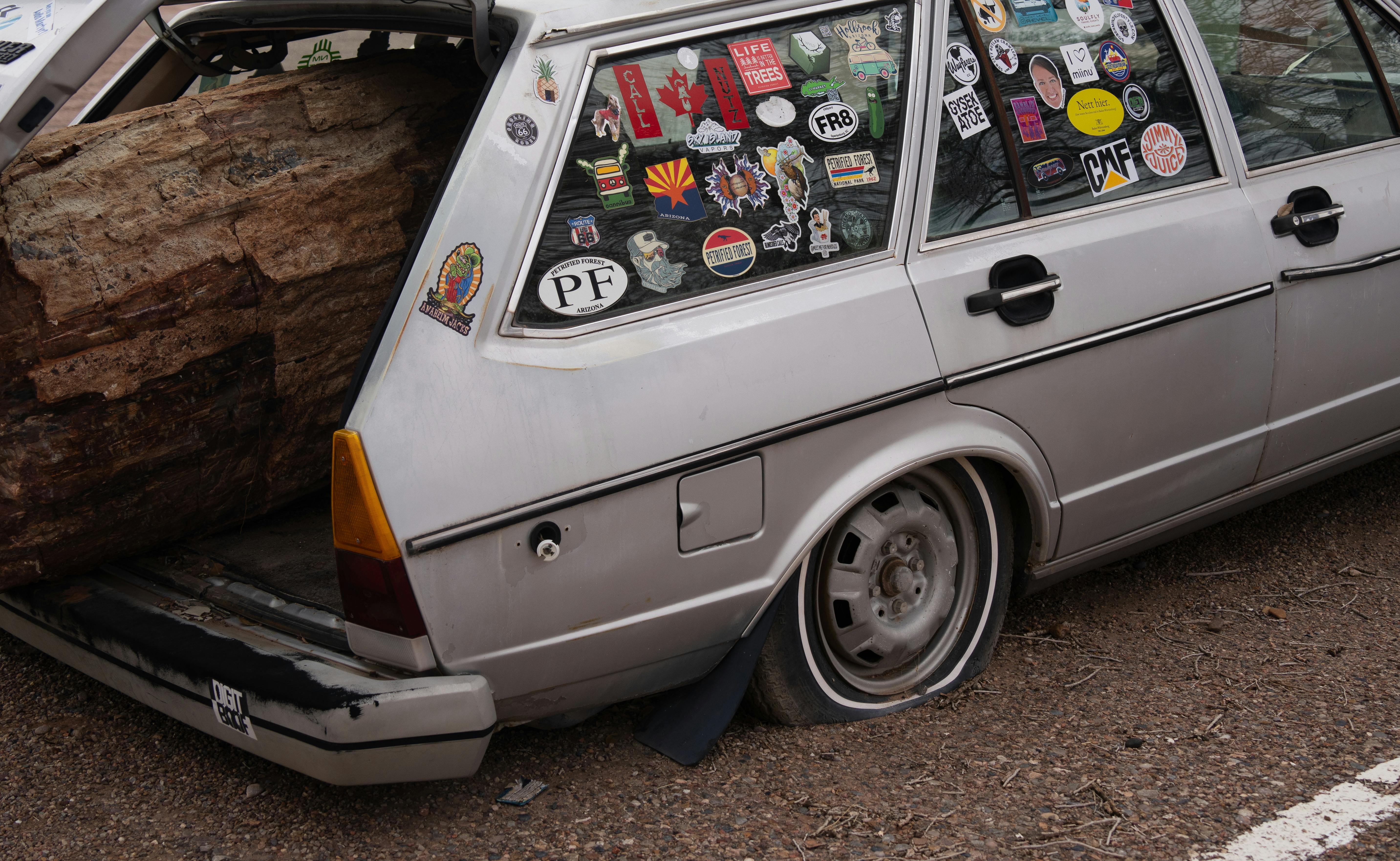 Stickers on Car with Flat Tire · Free Stock Photo