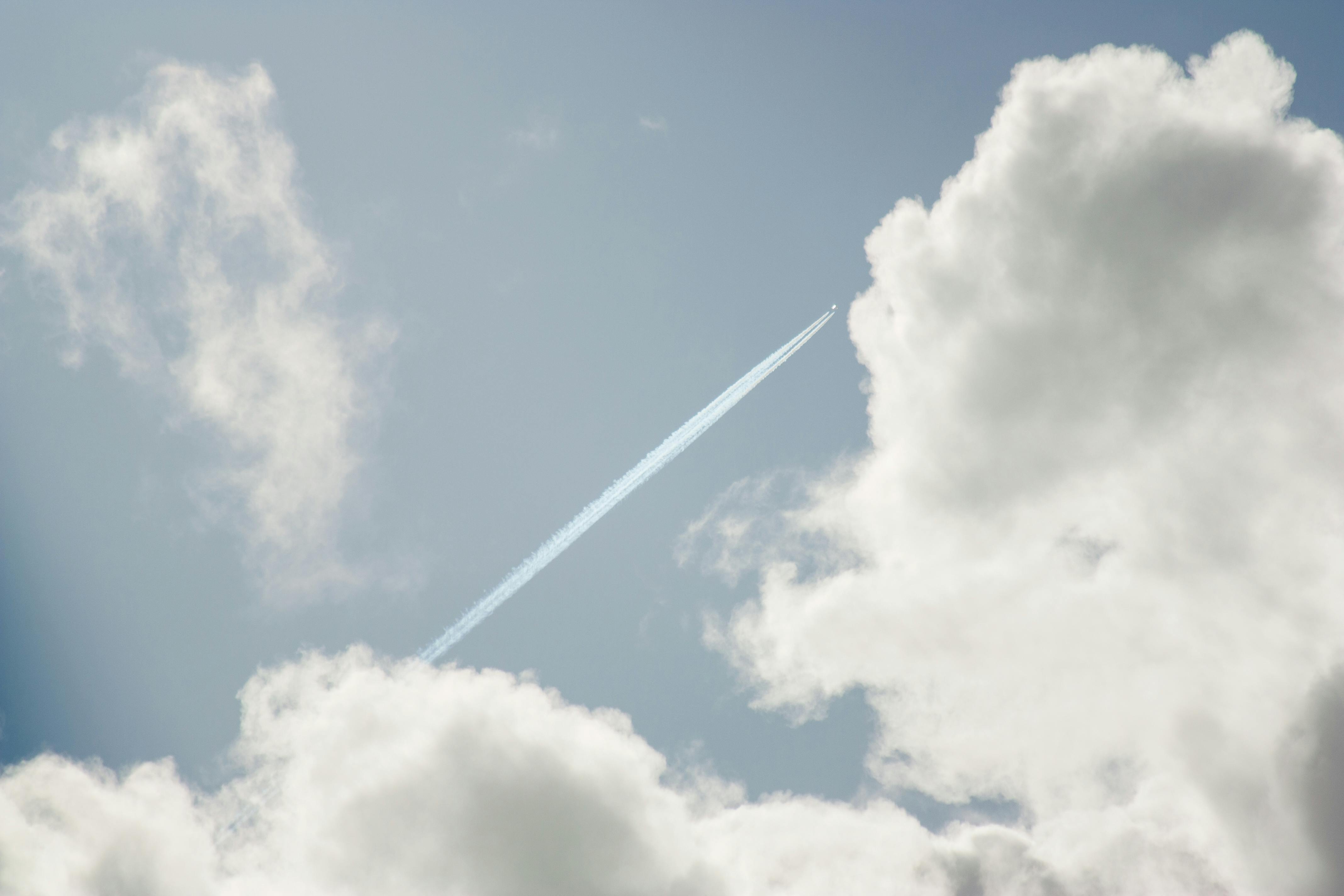 Contrail behind Clouds in Sky · Free Stock Photo