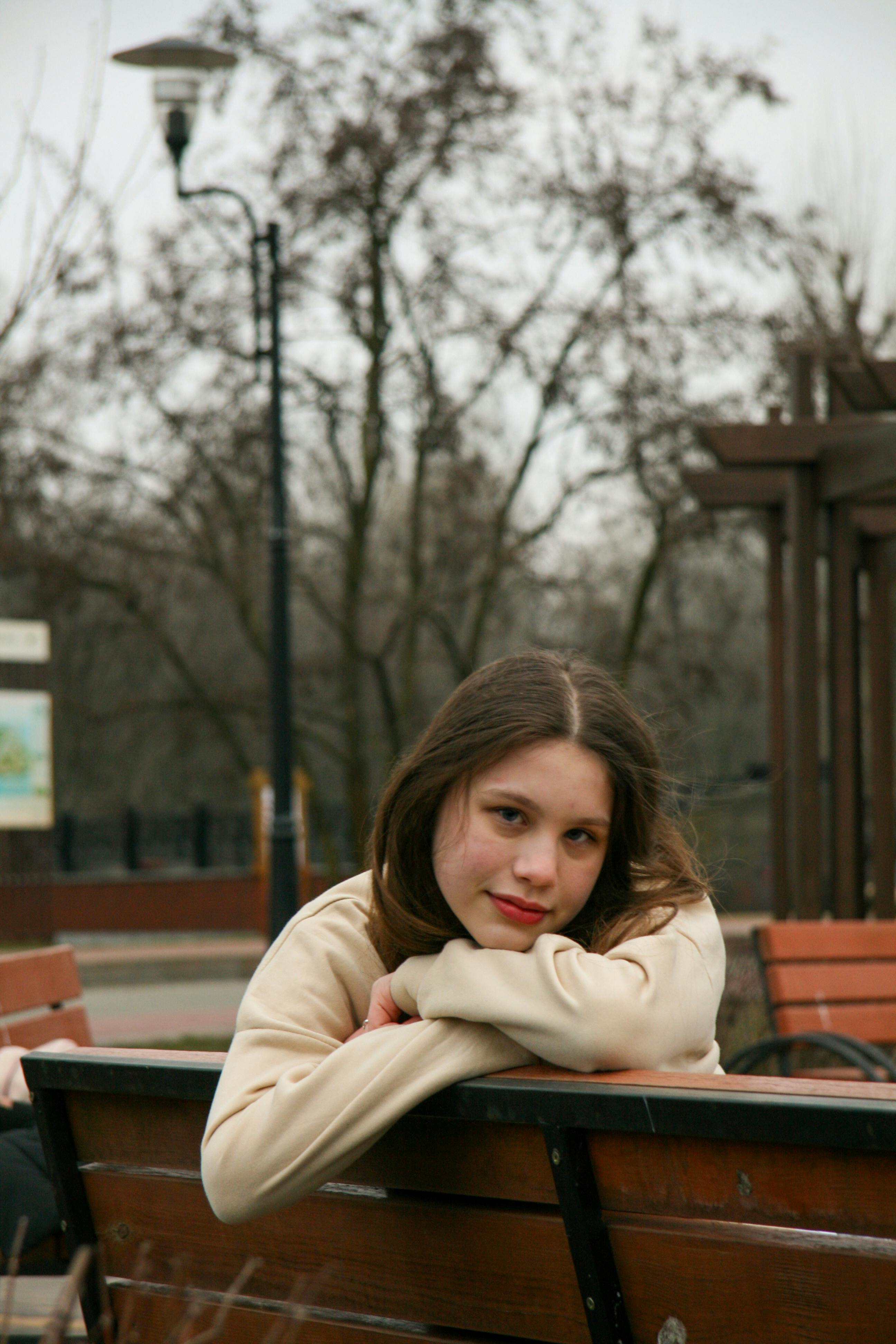 Women Leaning Cross Arms and Head on Bench · Free Stock Photo