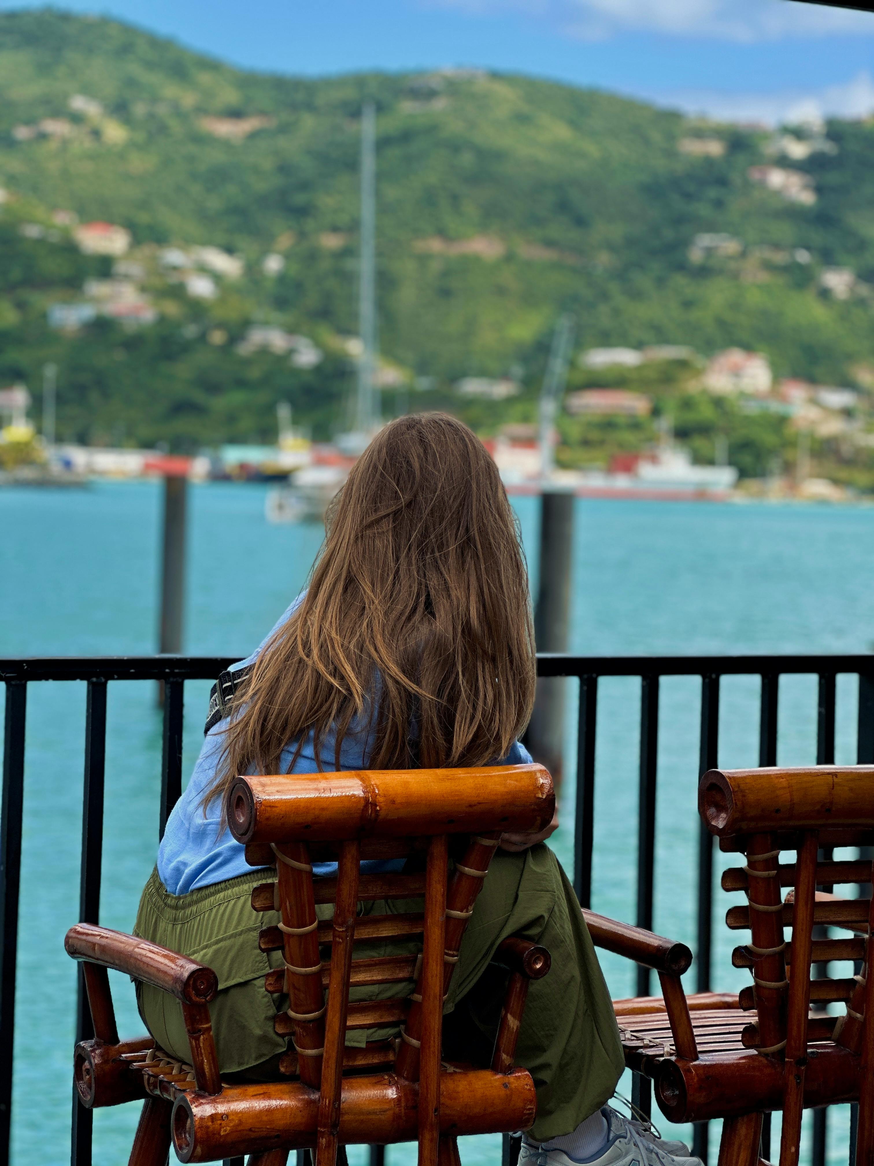 Tourist on a Terrace Overlooking the Bay · Free Stock Photo