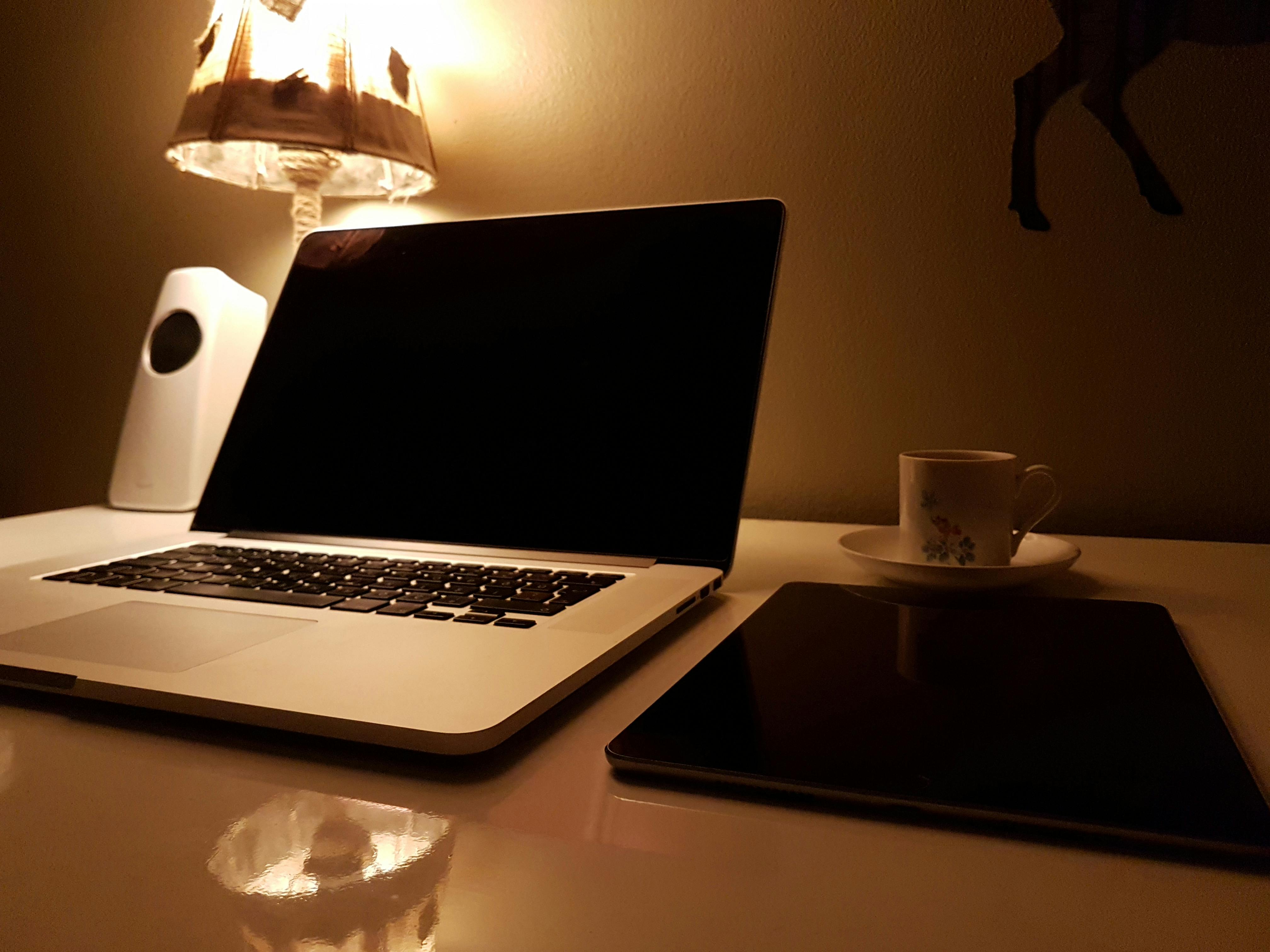 Man Using Laptop on Table Against White Background · Free Stock Photo
