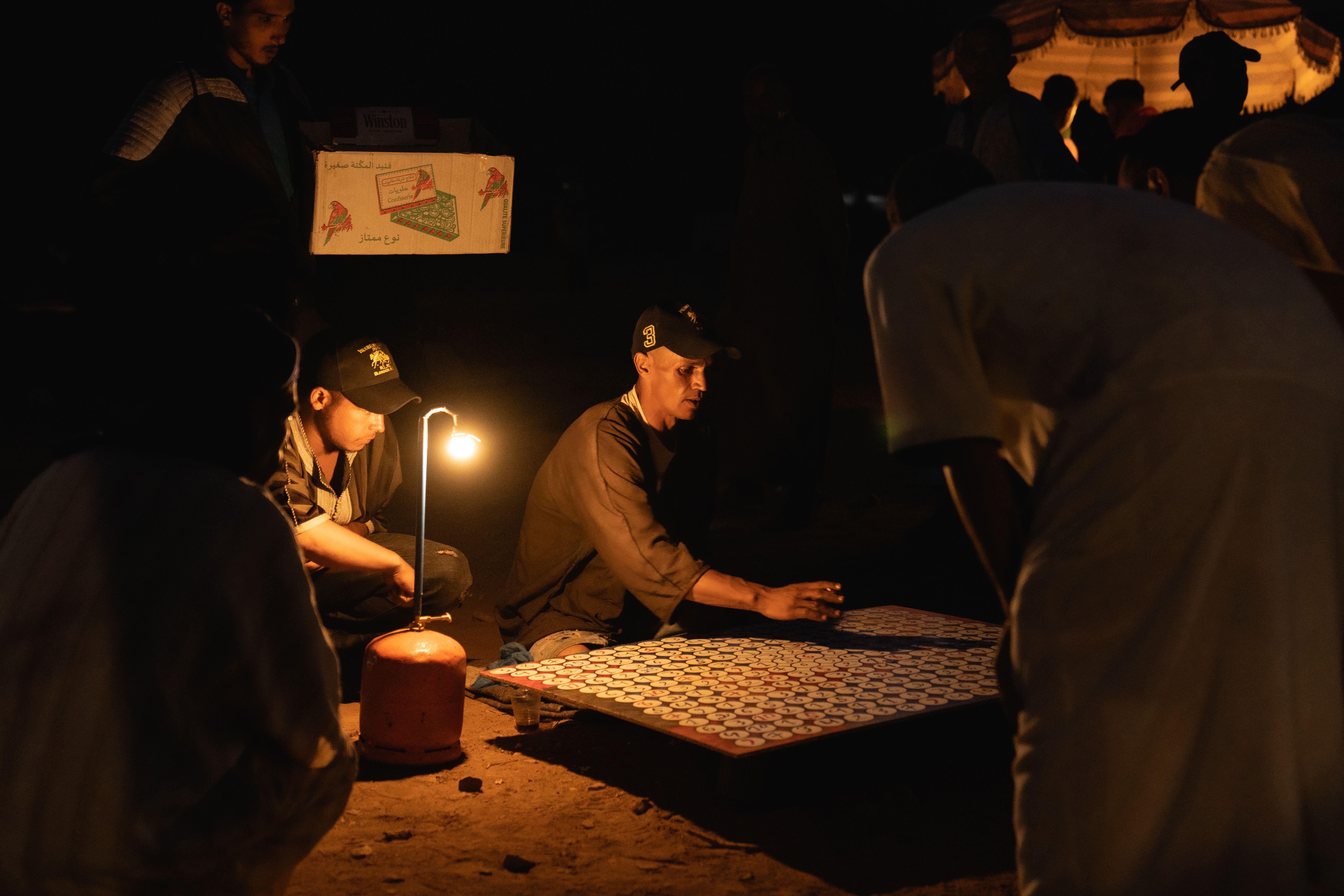 Man and People Playing Board Game at Night · Free Stock Photo