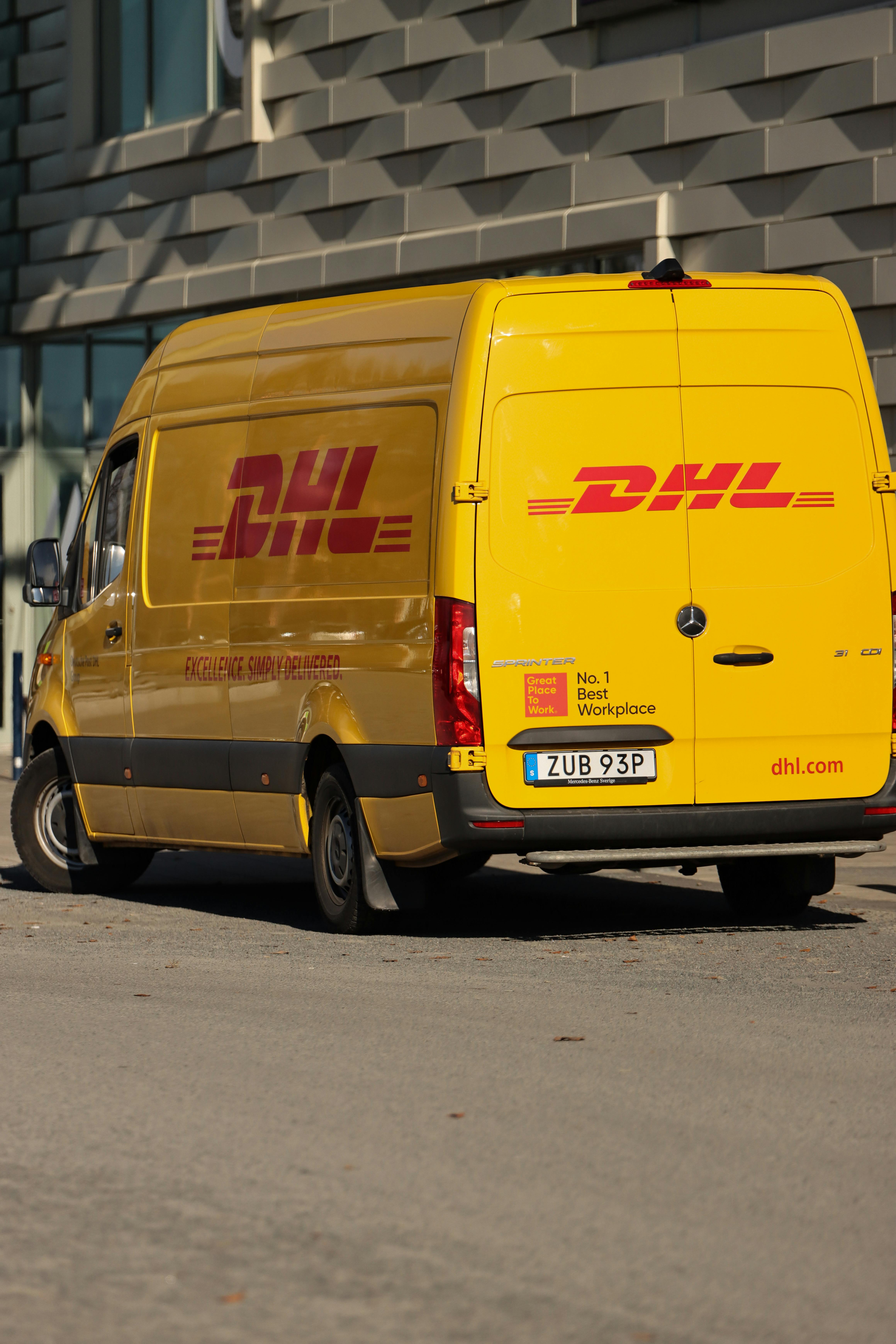 DHL Yellow Bus on Street in Sweden · Free Stock Photo