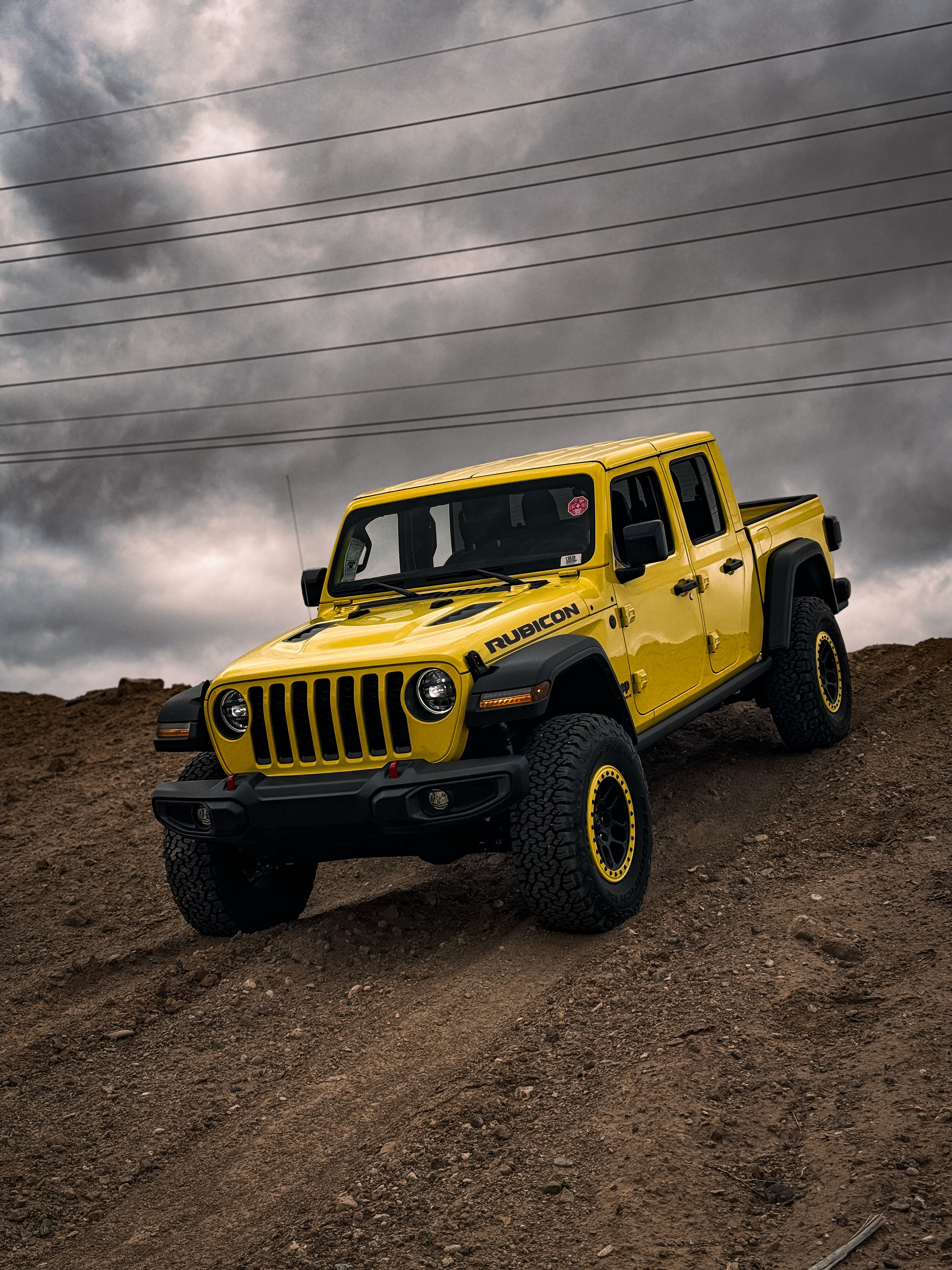 Yellow Car on a Dirt Road, and Electricity Wires against the Sky in ...