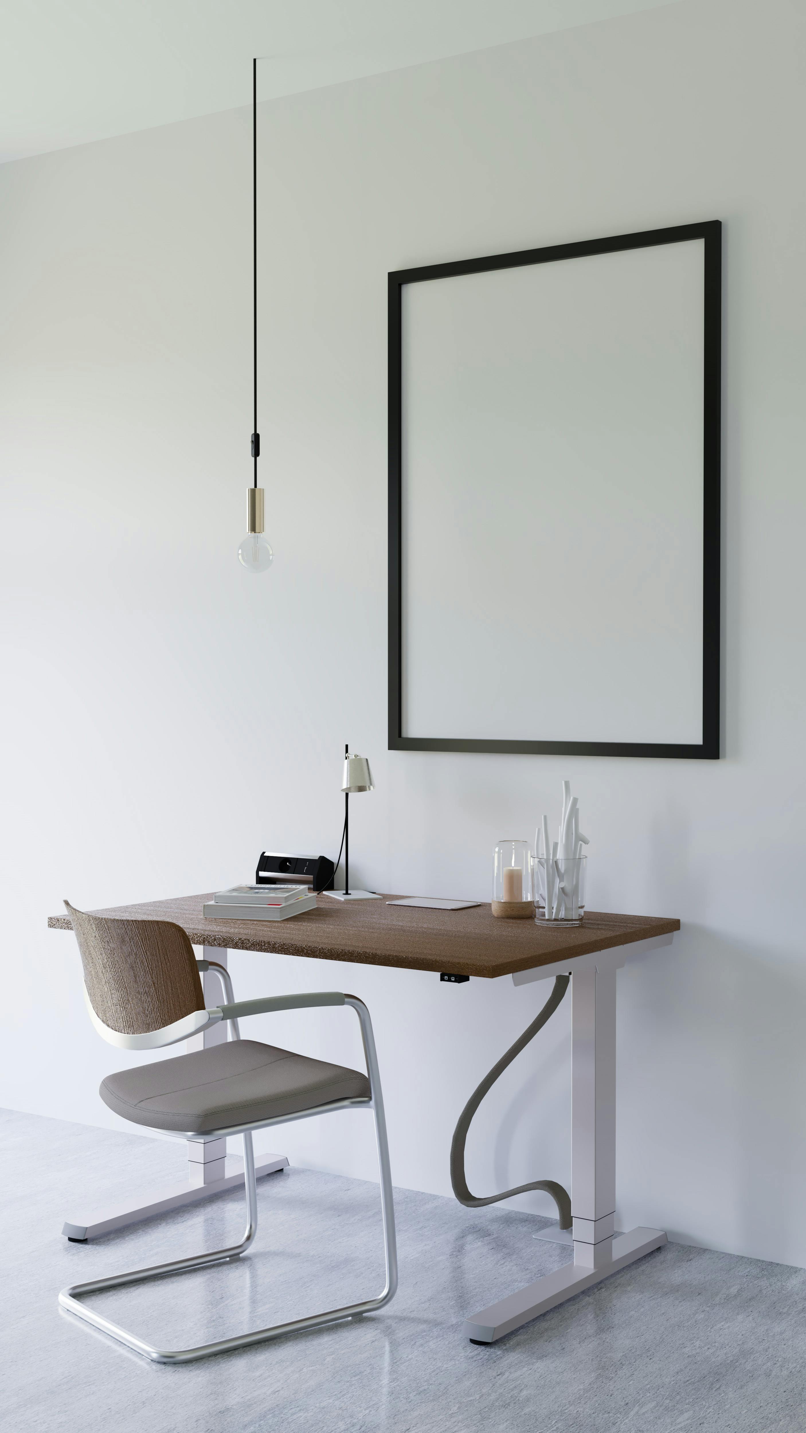 A white desk with a chair and a picture frame · Free Stock Photo