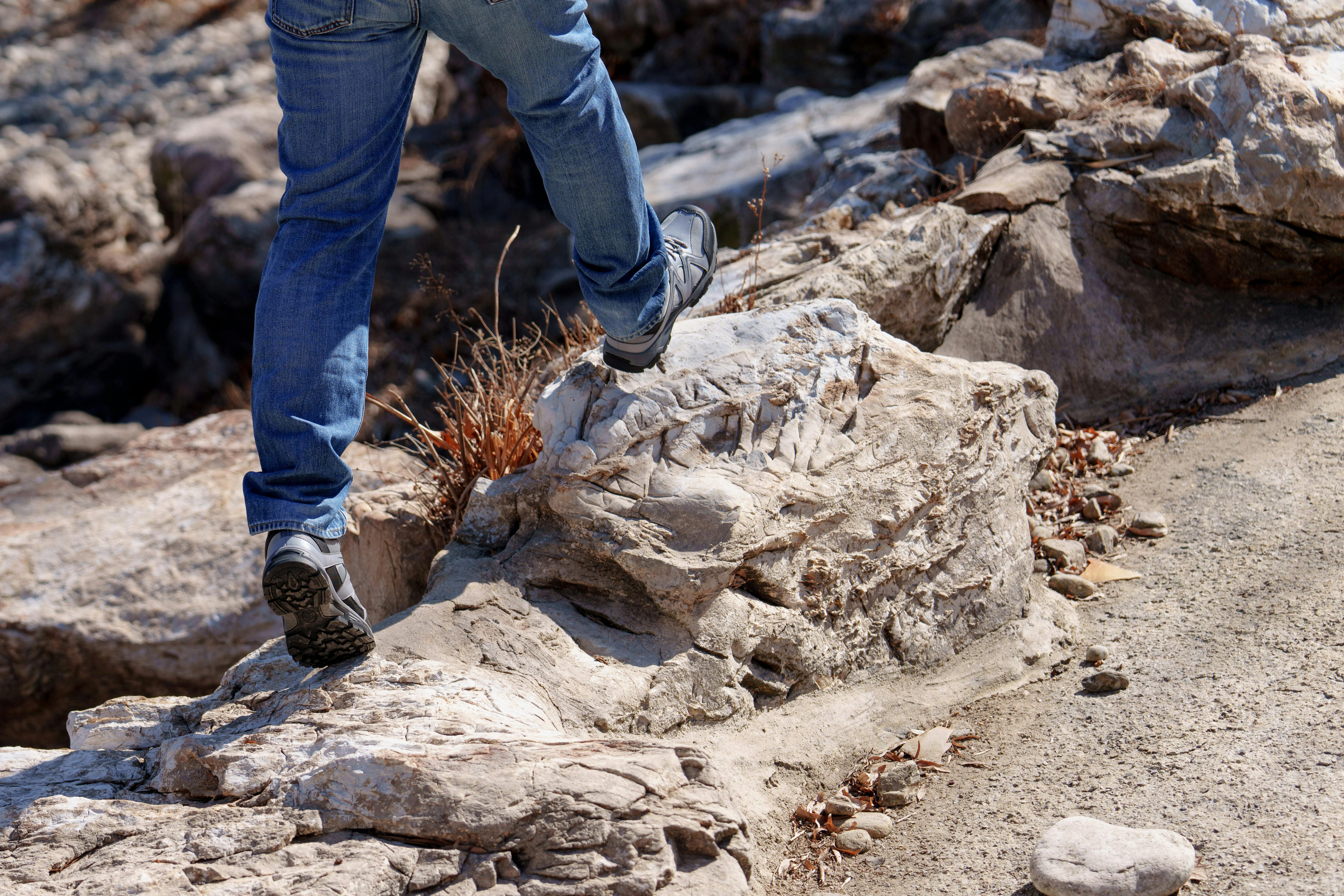 Man Walking on Stones on a Desert · Free Stock Photo