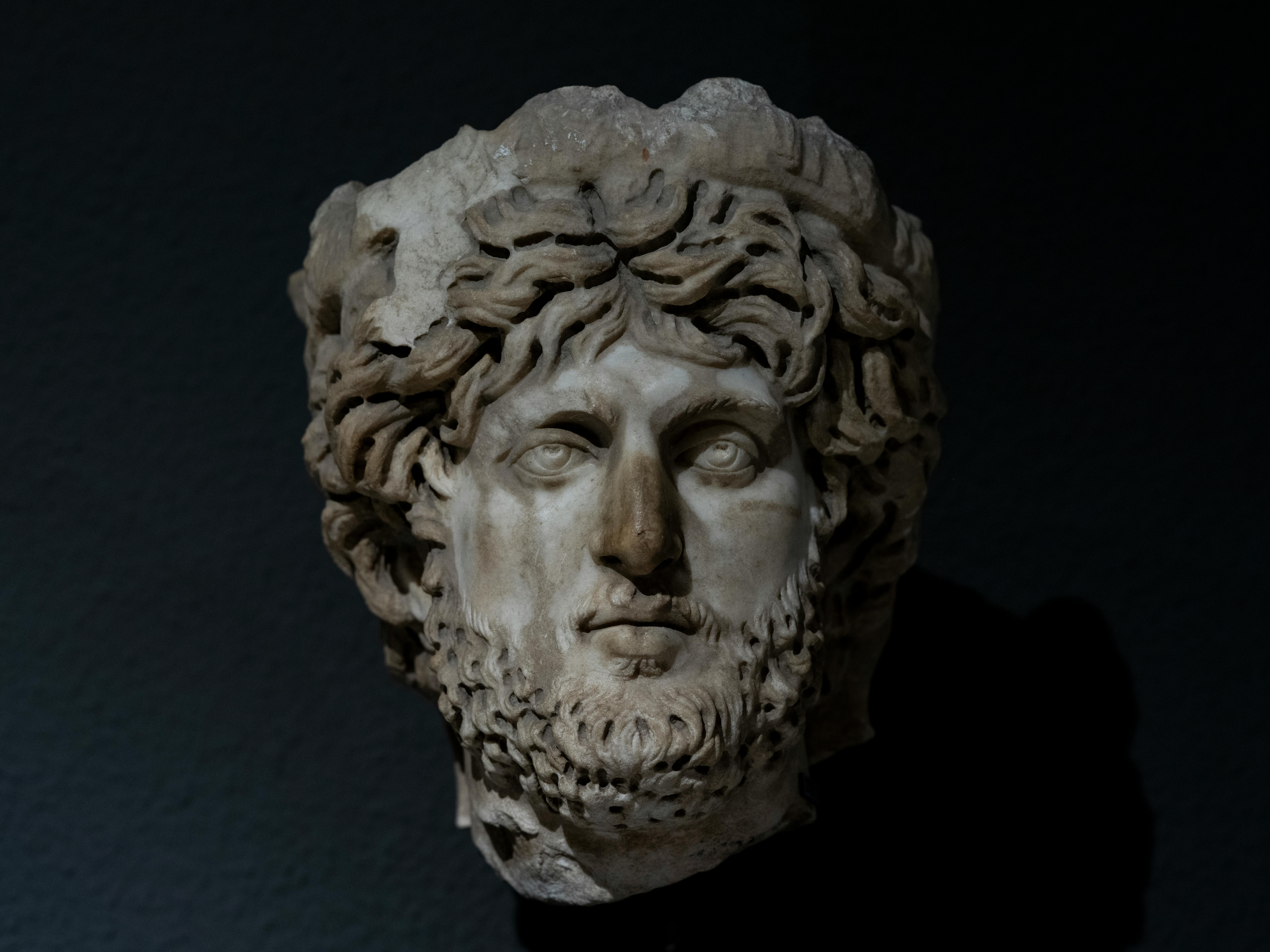 Head of a Stone Statue Depicting a Man · Free Stock Photo