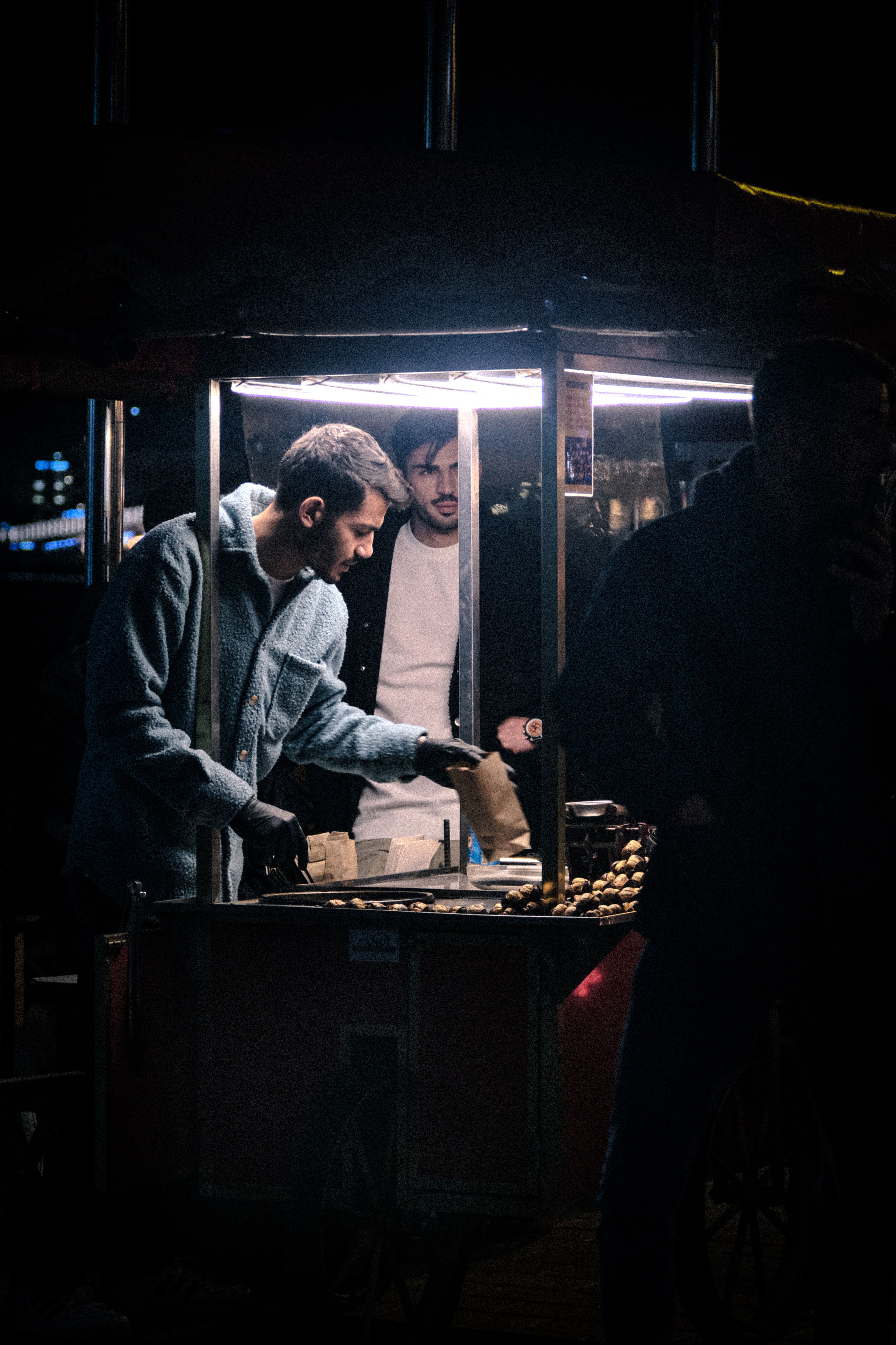 Man in Front of Food Booth in the Dark · Free Stock Photo