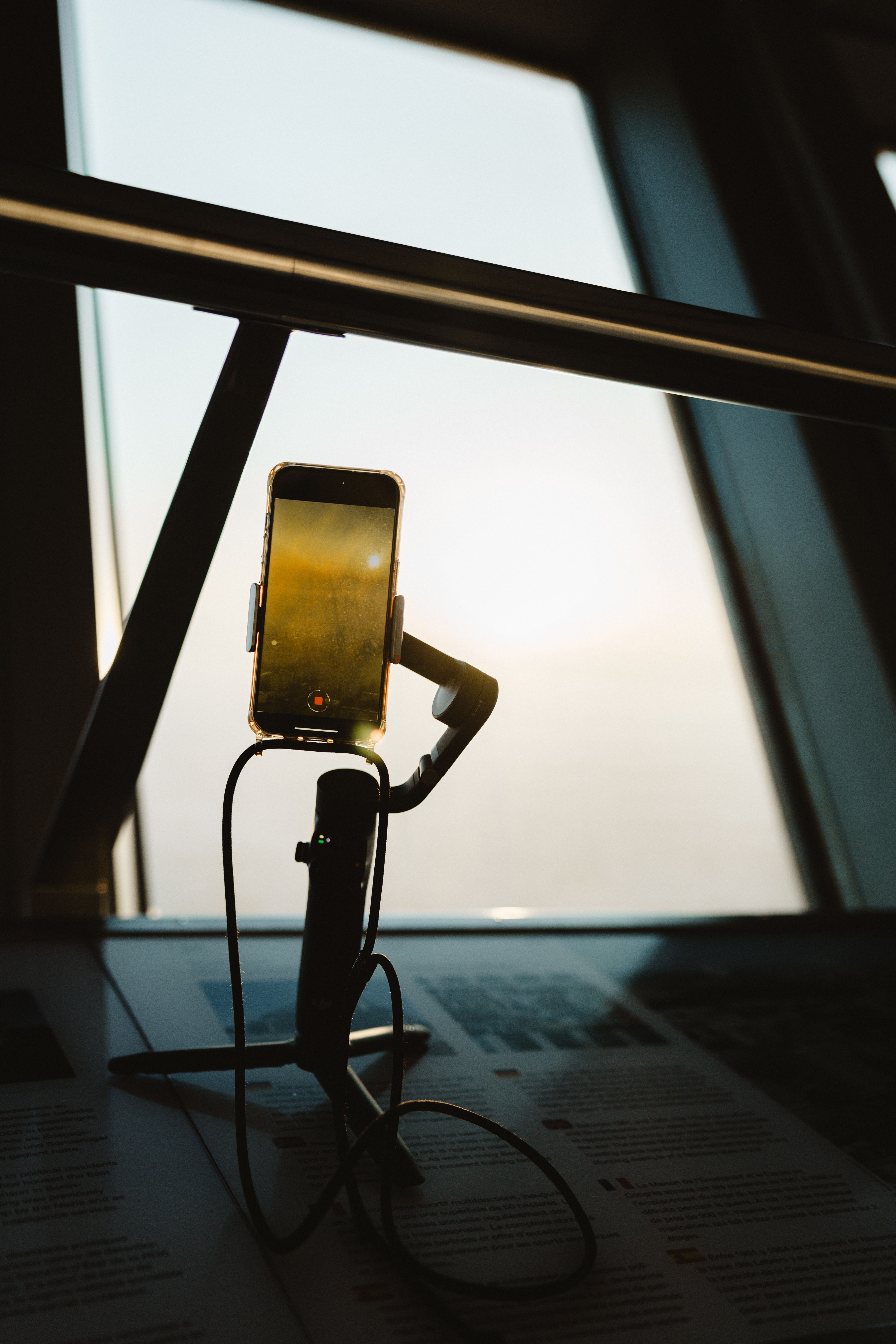 Mobile Phone on a Stick During Sunset · Free Stock Photo