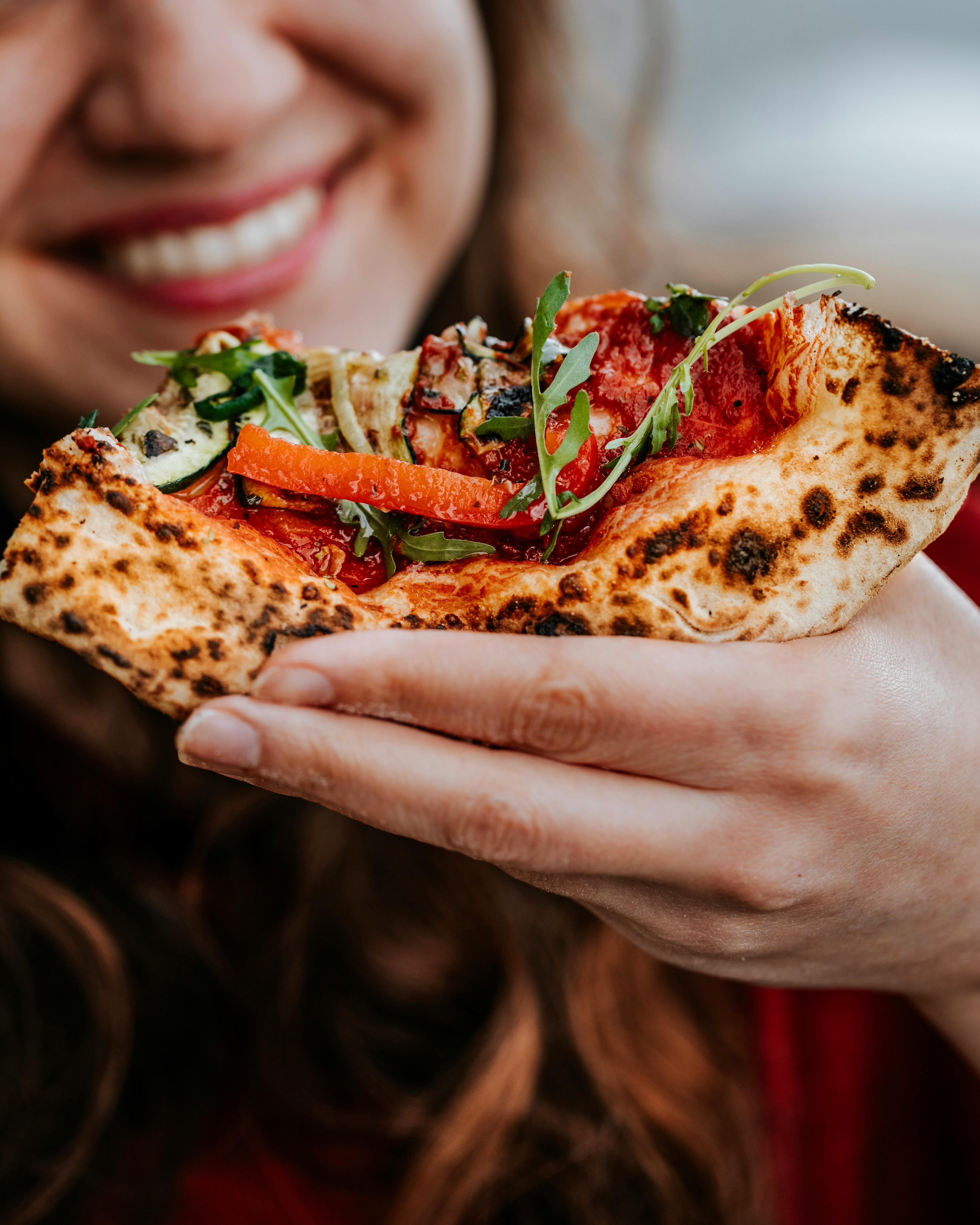 Pizza Slice in Hand · Free Stock Photo