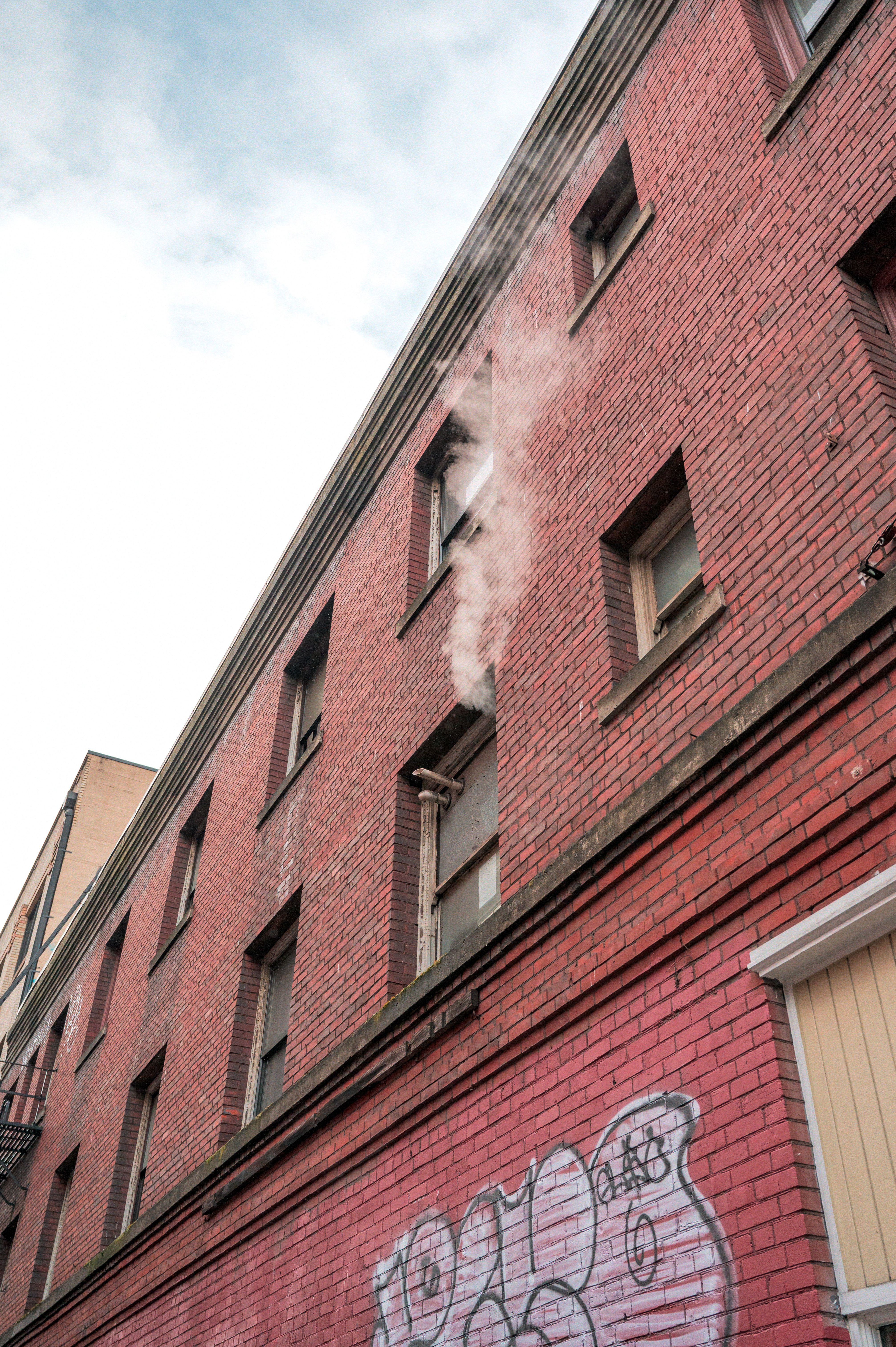 A building with graffiti on it and smoke coming out of it · Free Stock ...