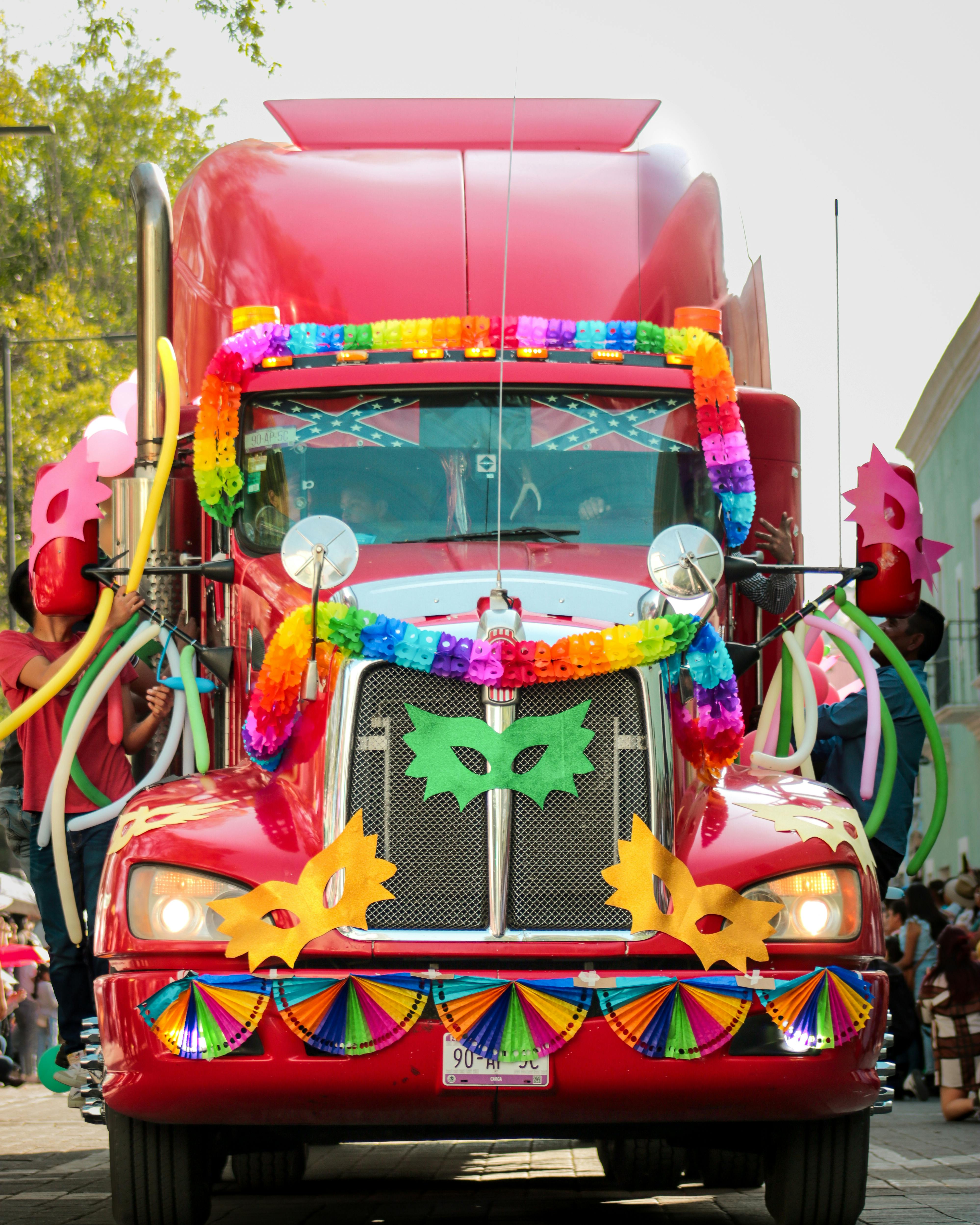 A colorful truck decorated with flowers and a parade · Free Stock Photo