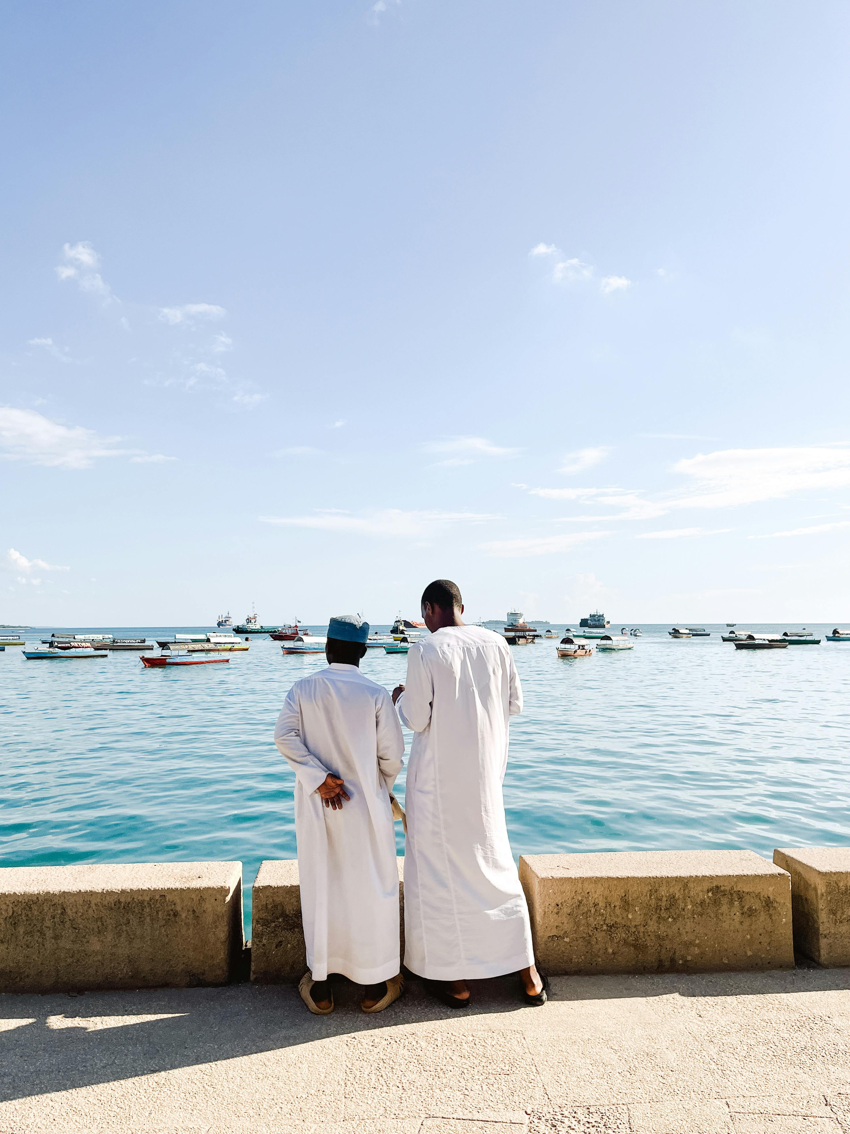 Two People Standing by a Sea · Free Stock Photo