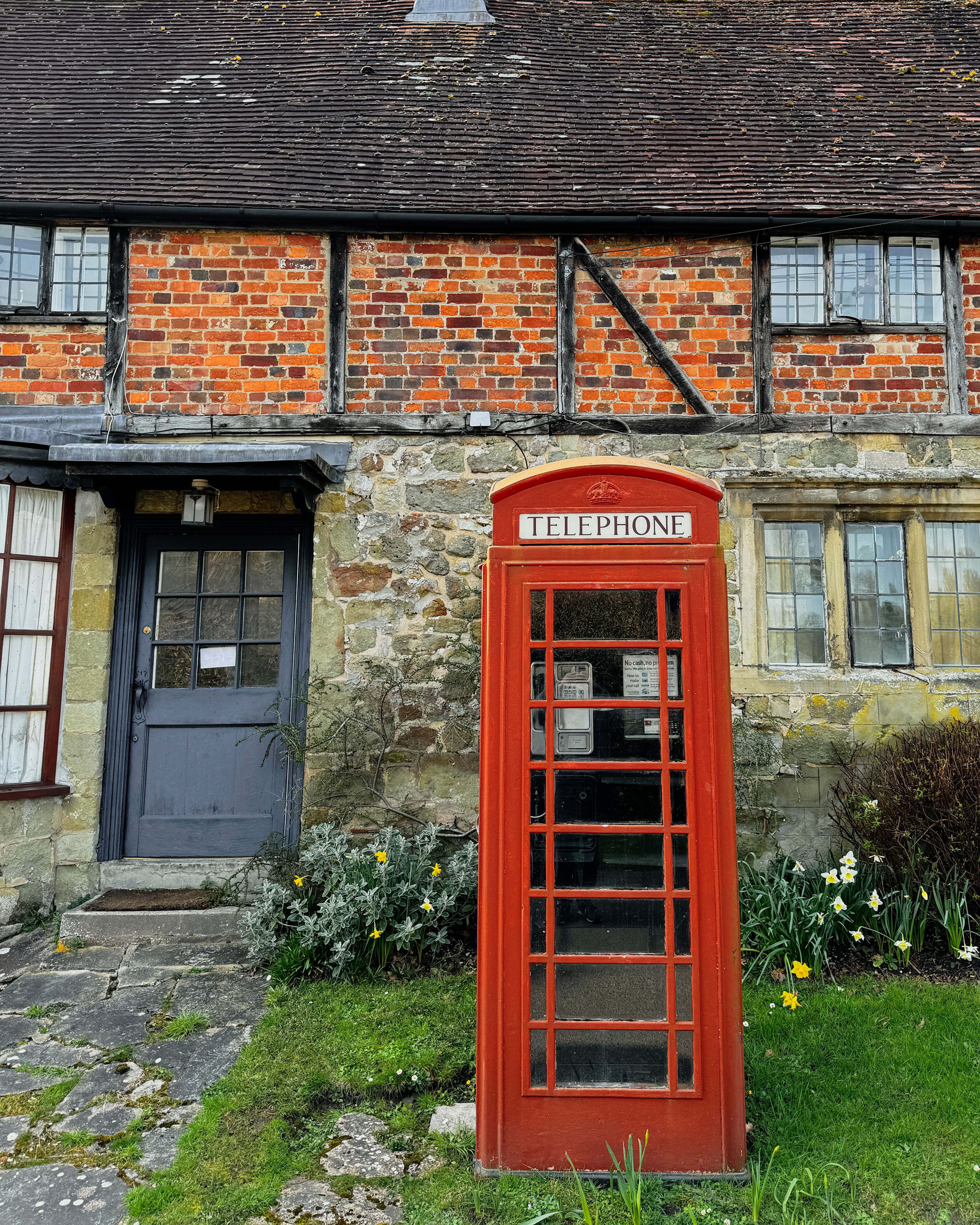 Phone Booth near Vintage House in Village · Free Stock Photo