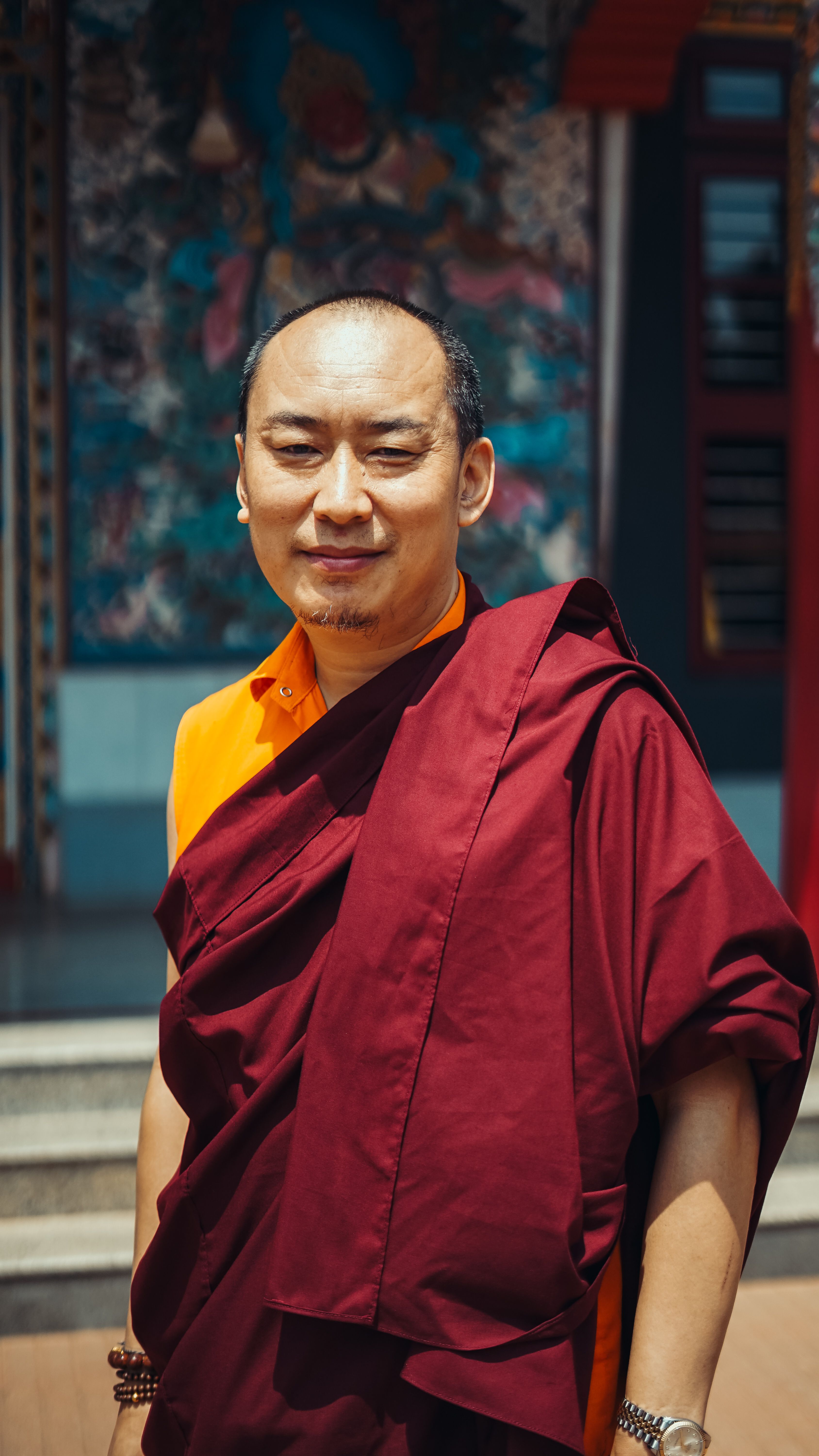 Photo of a Monk Standing in Sunlight · Free Stock Photo