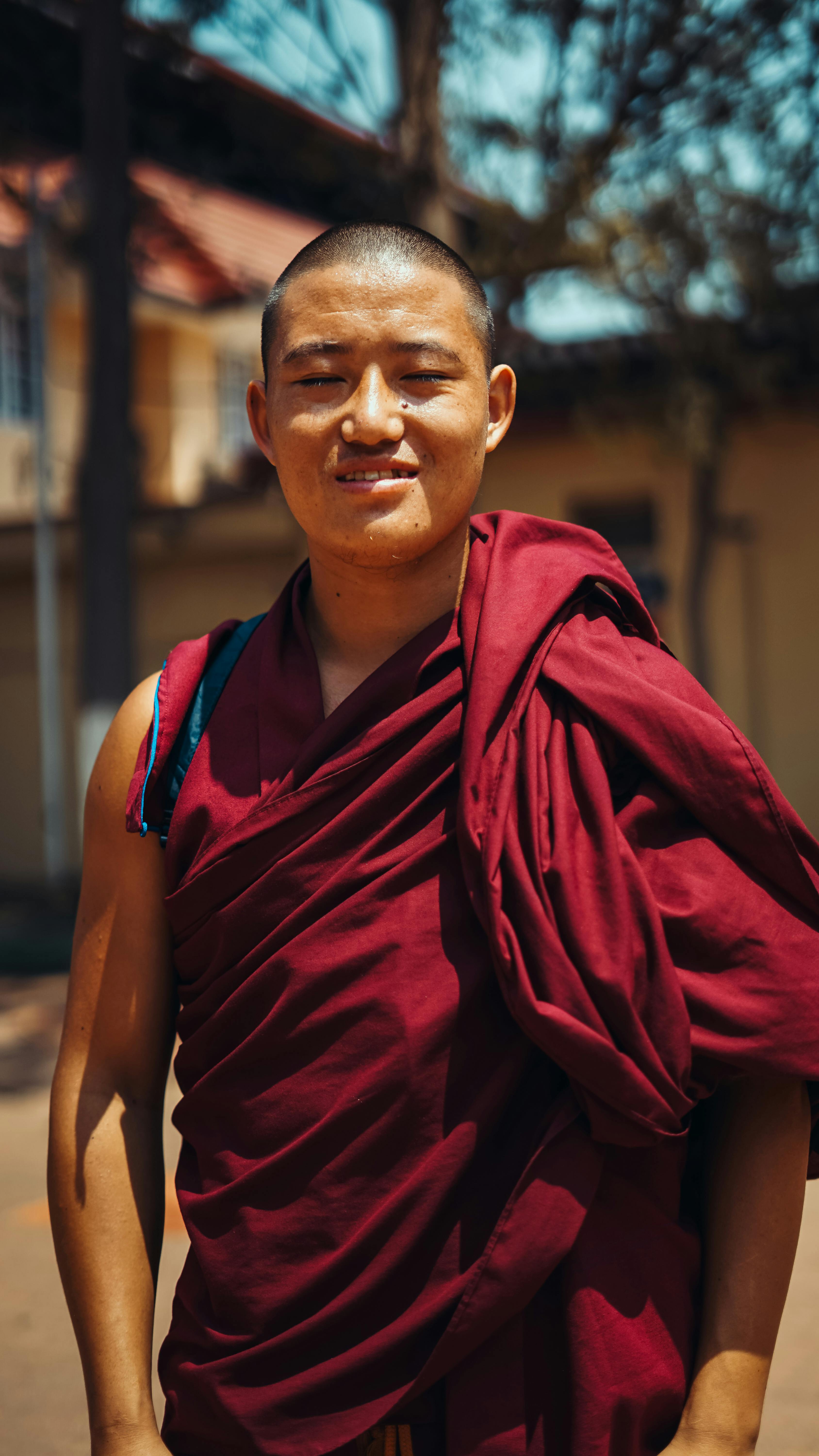 Portrait of a Young Monk Wearing a Red Robe · Free Stock Photo