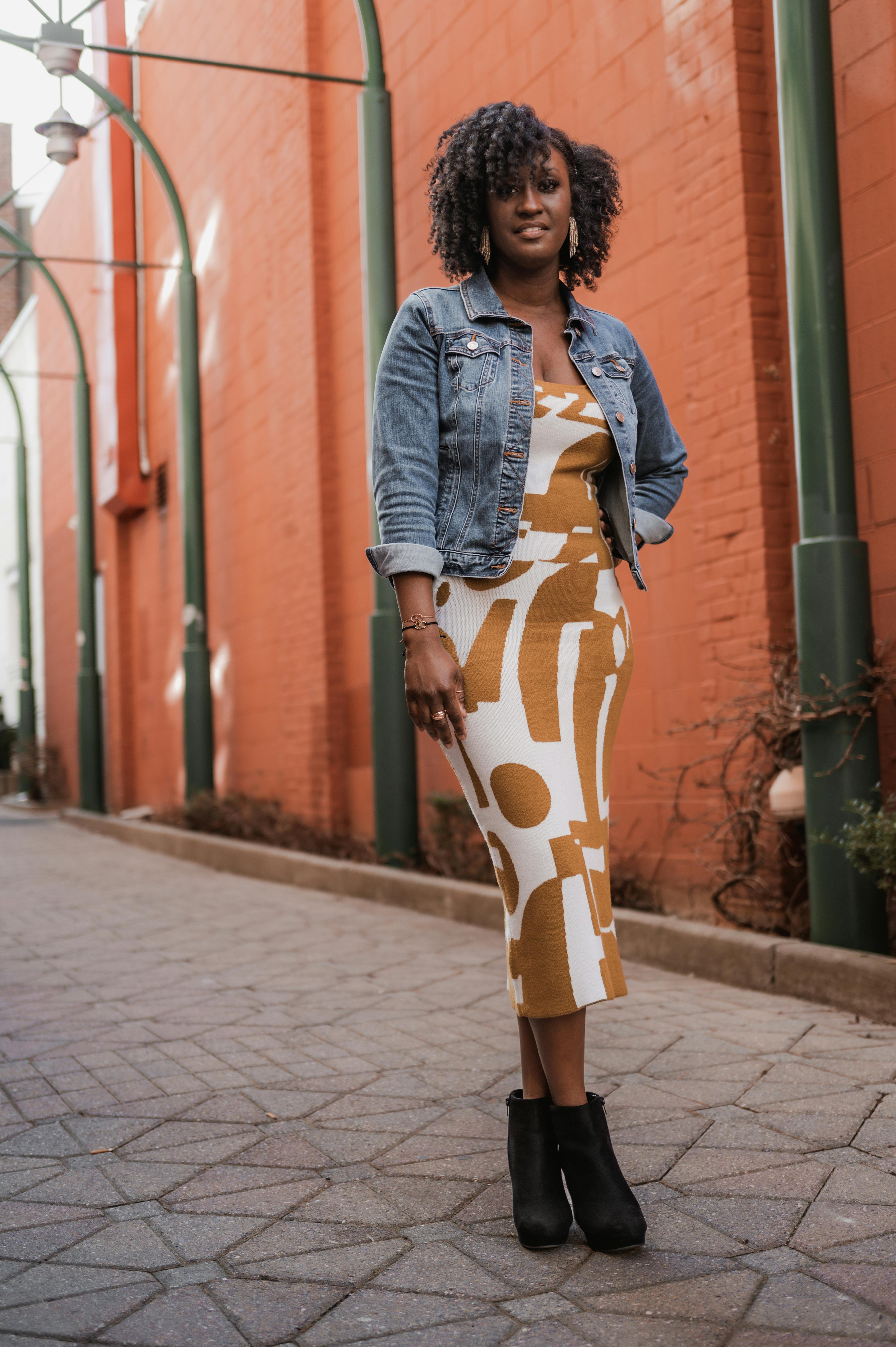 Model in Denim Jacket and White Dress with Brown Print Posing on ...