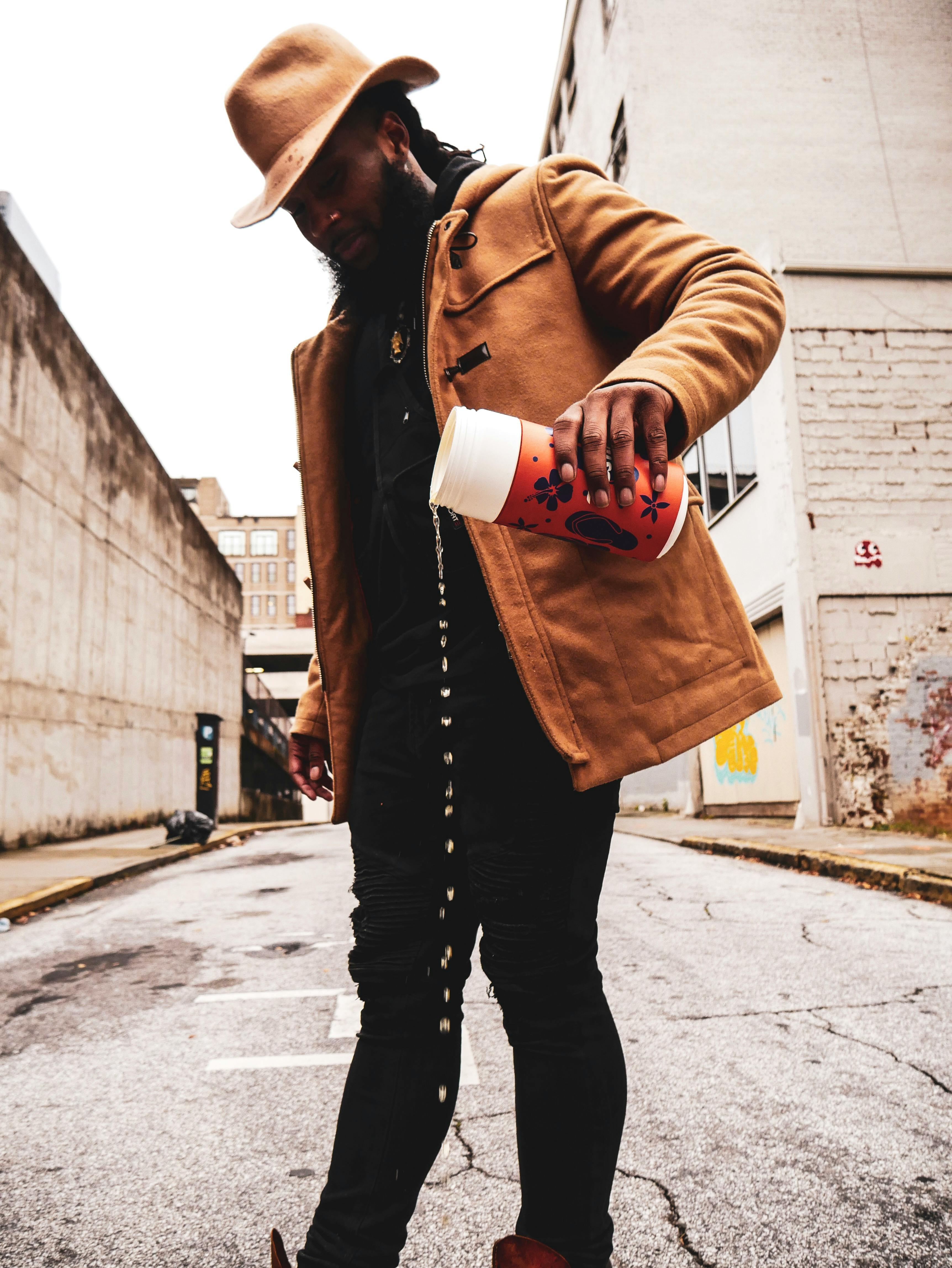 Photo of Man Standing Near Rocky Lake · Free Stock Photo