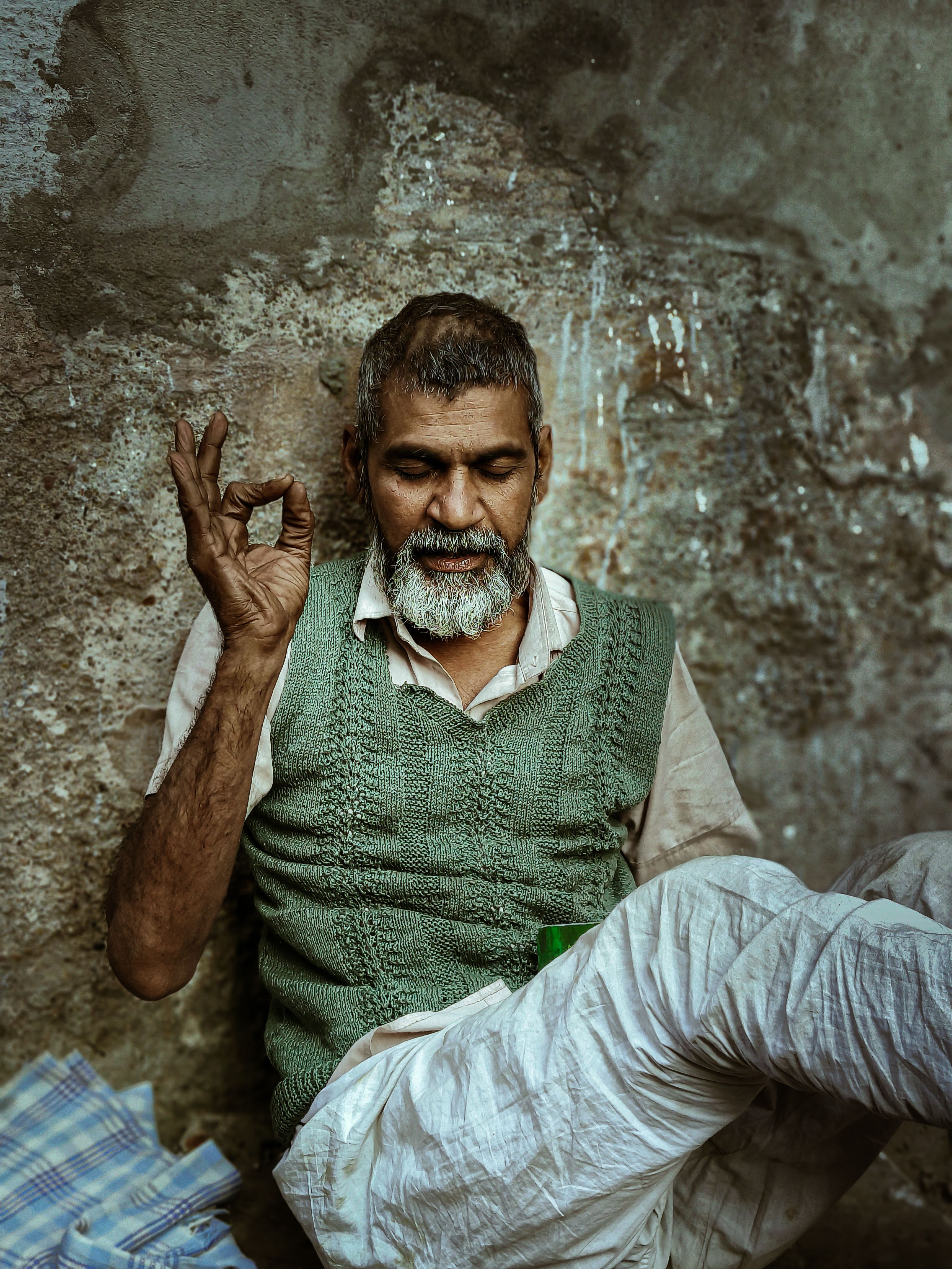 Man Sitting against a Rock · Free Stock Photo