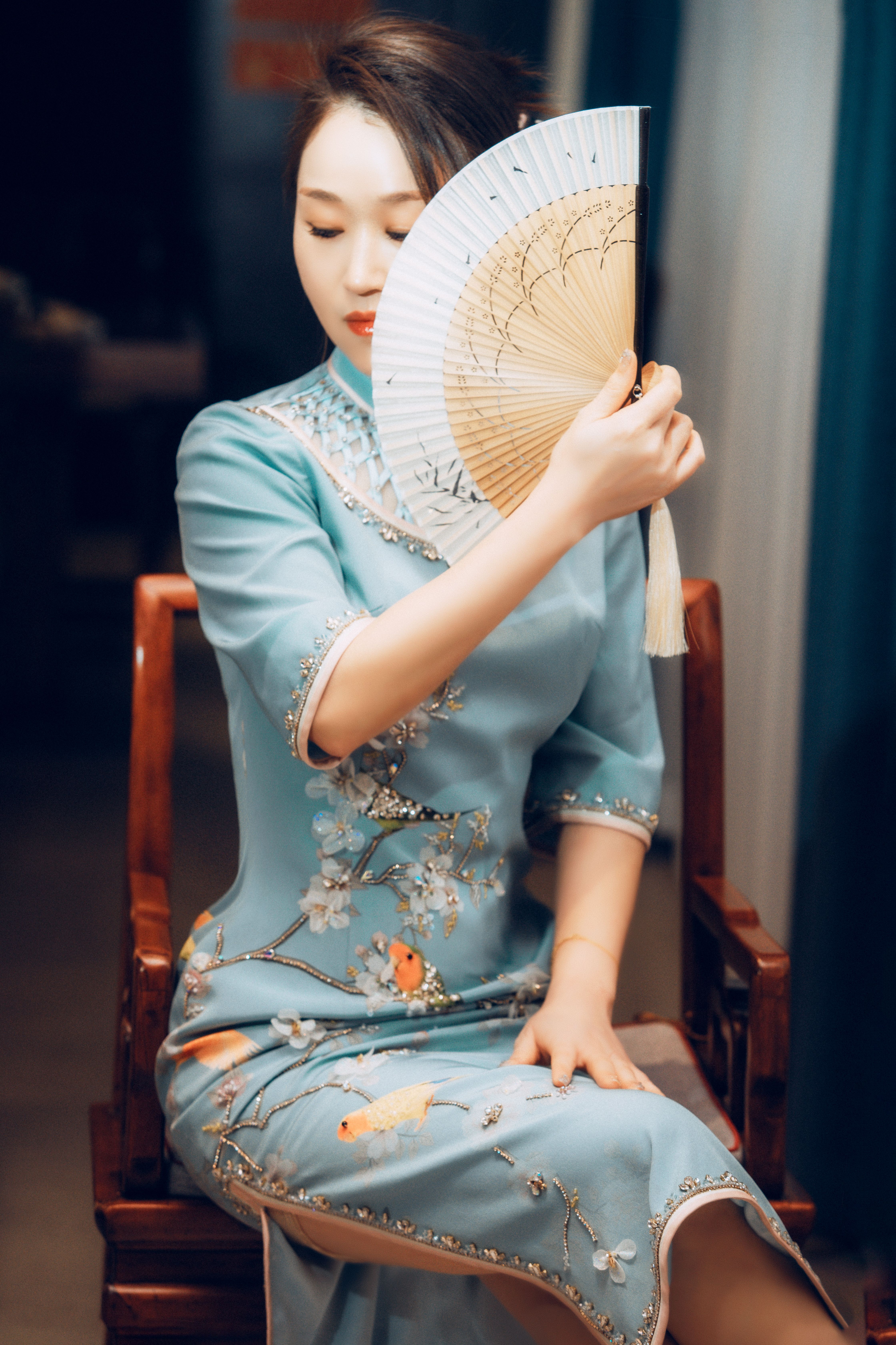 Photo of Woman Sitting While Holding Her Fan · Free Stock Photo