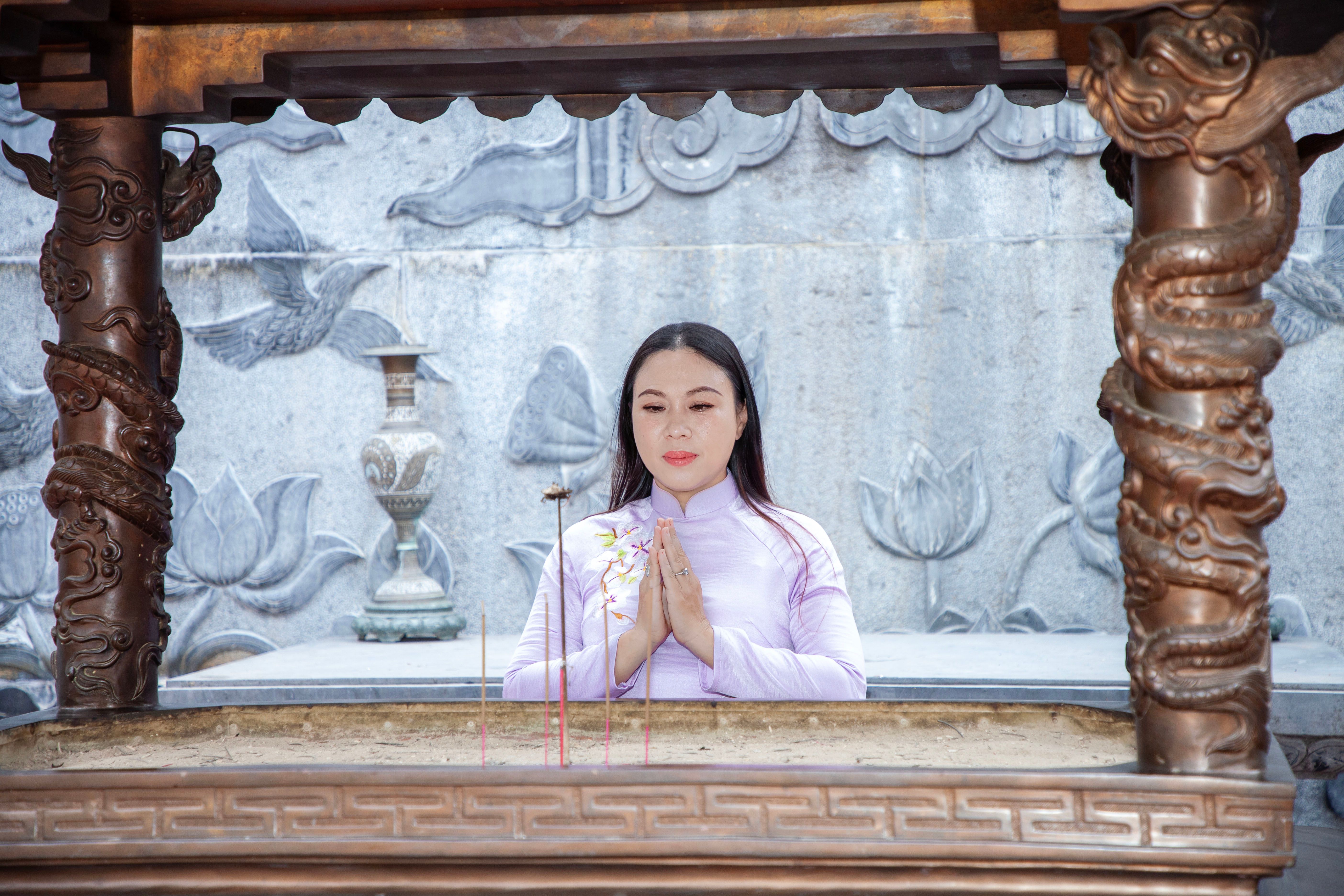 Photo of a Woman Praying in a Temple · Free Stock Photo