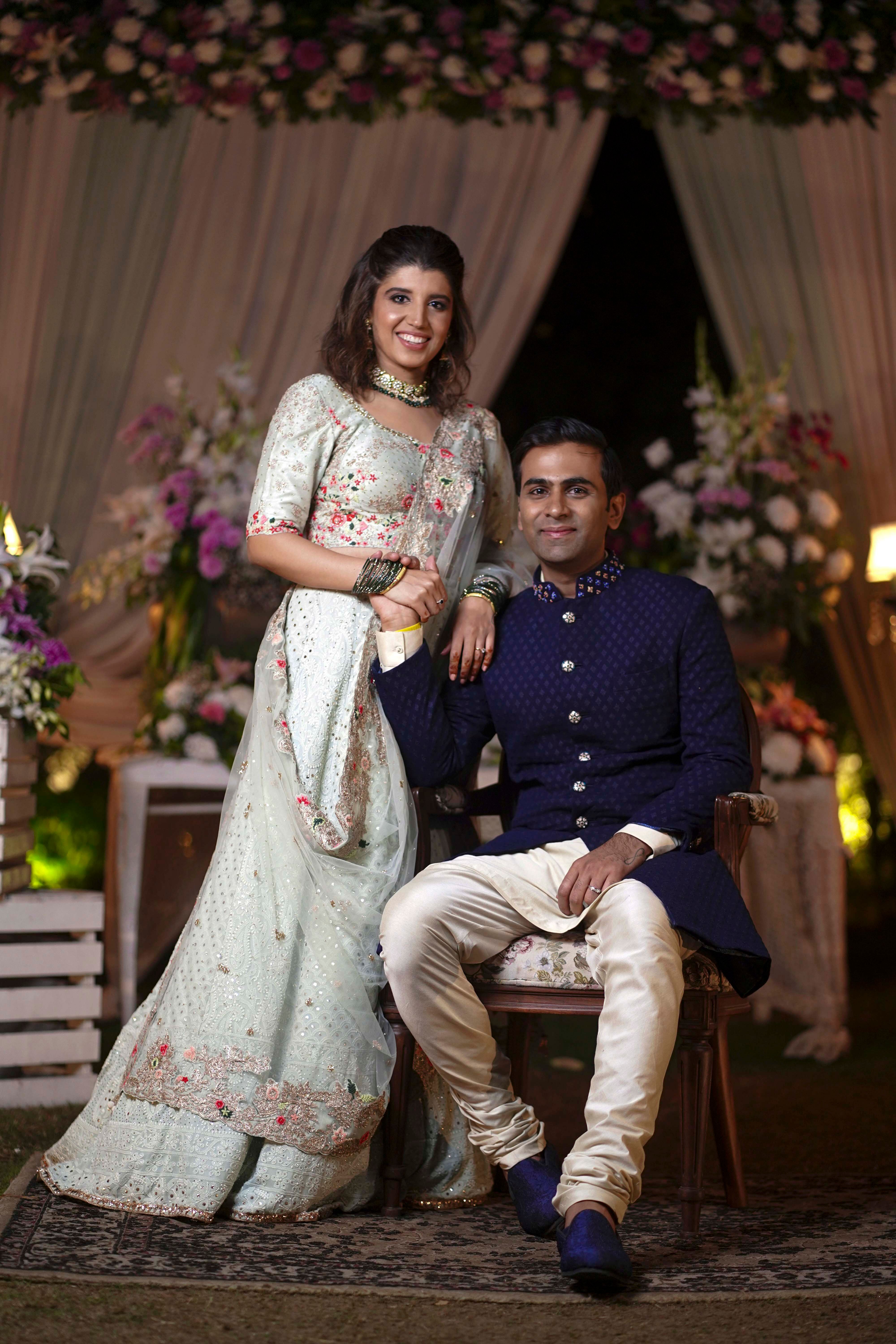 A couple in traditional attire pose for a photo · Free Stock Photo