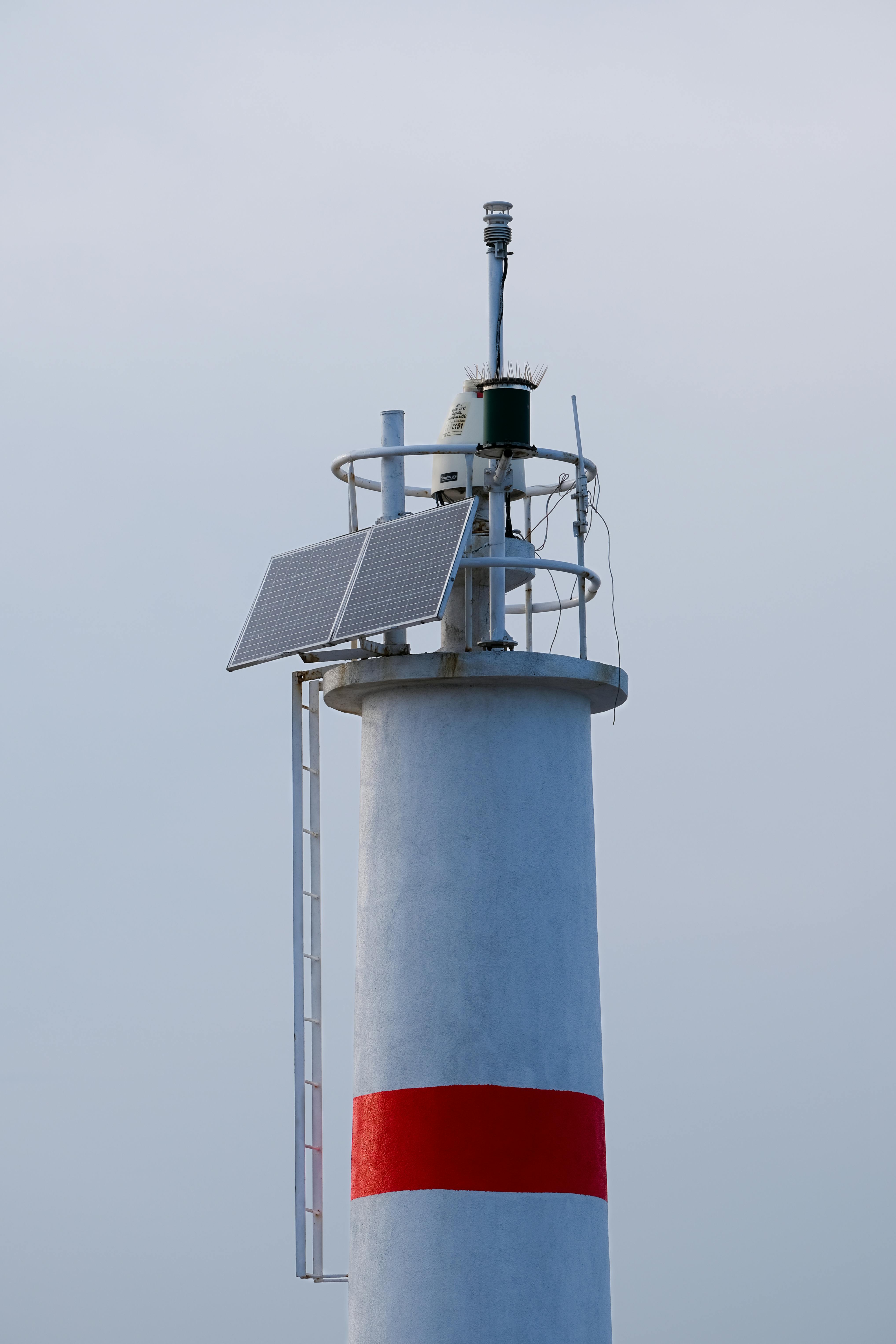 A lighthouse with a solar panel on top · Free Stock Photo