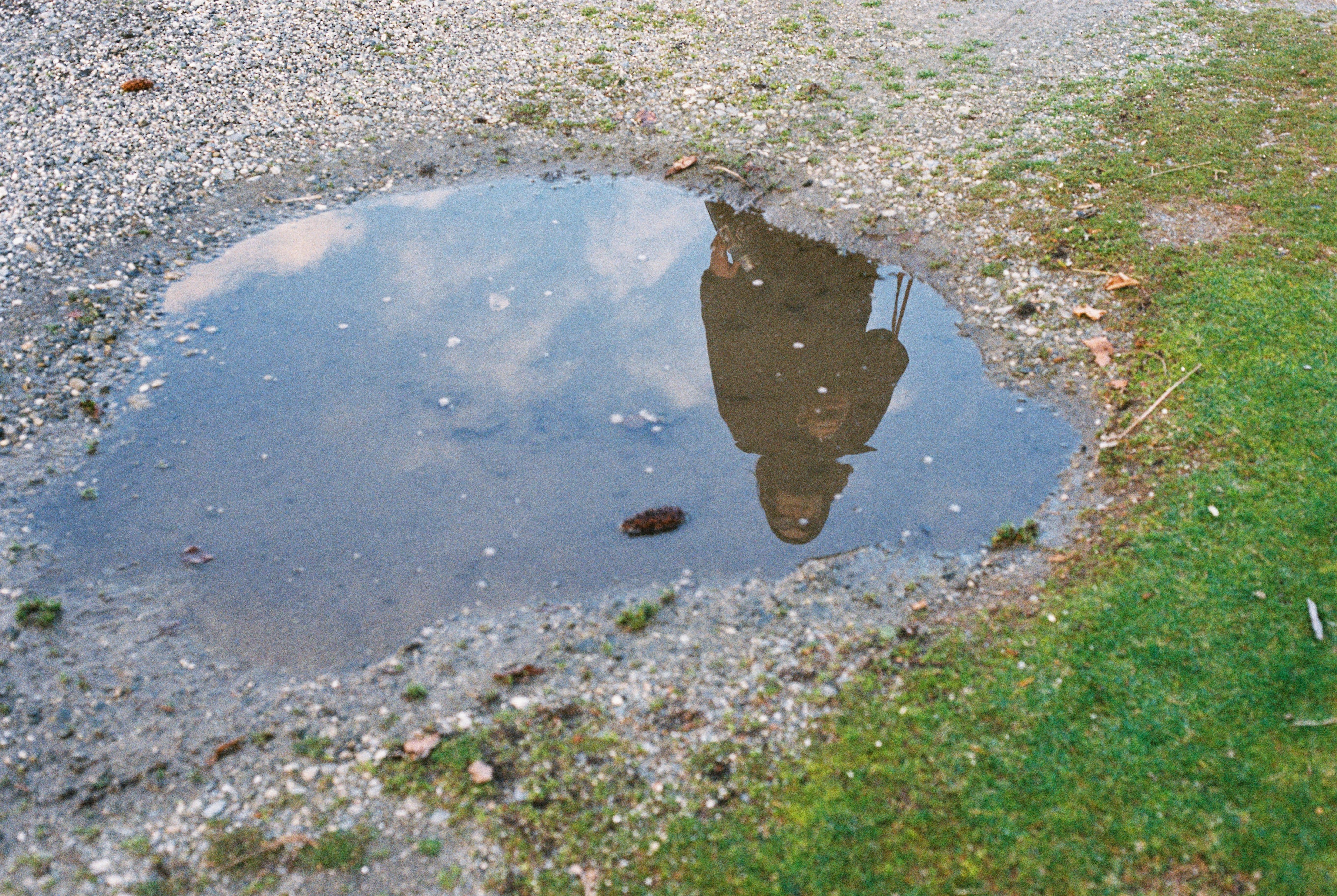A person standing in a puddle of water · Free Stock Photo