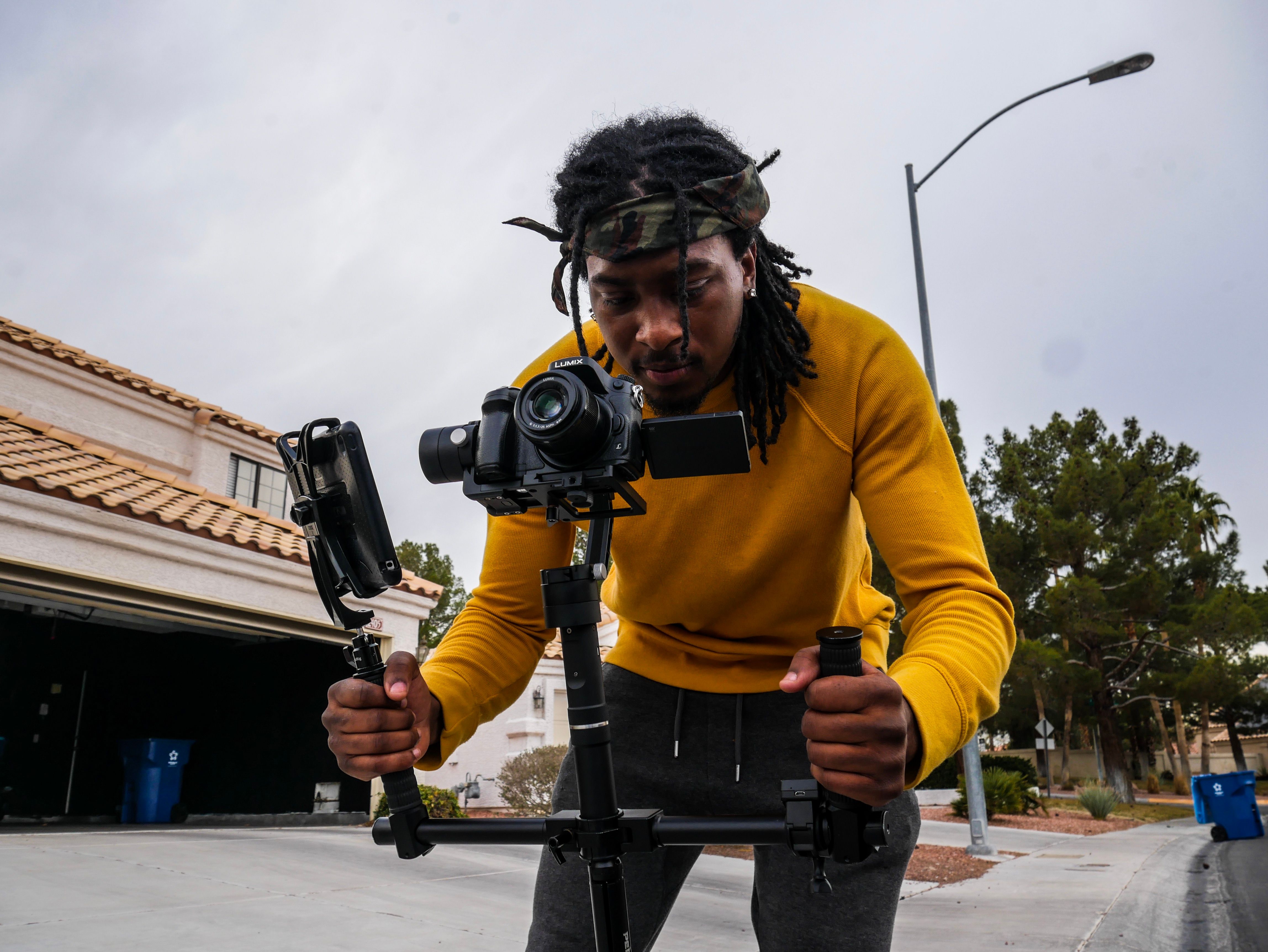 Man Wearing Yellow Long-sleeved Shirt Holding Camera Stand · Free Stock ...