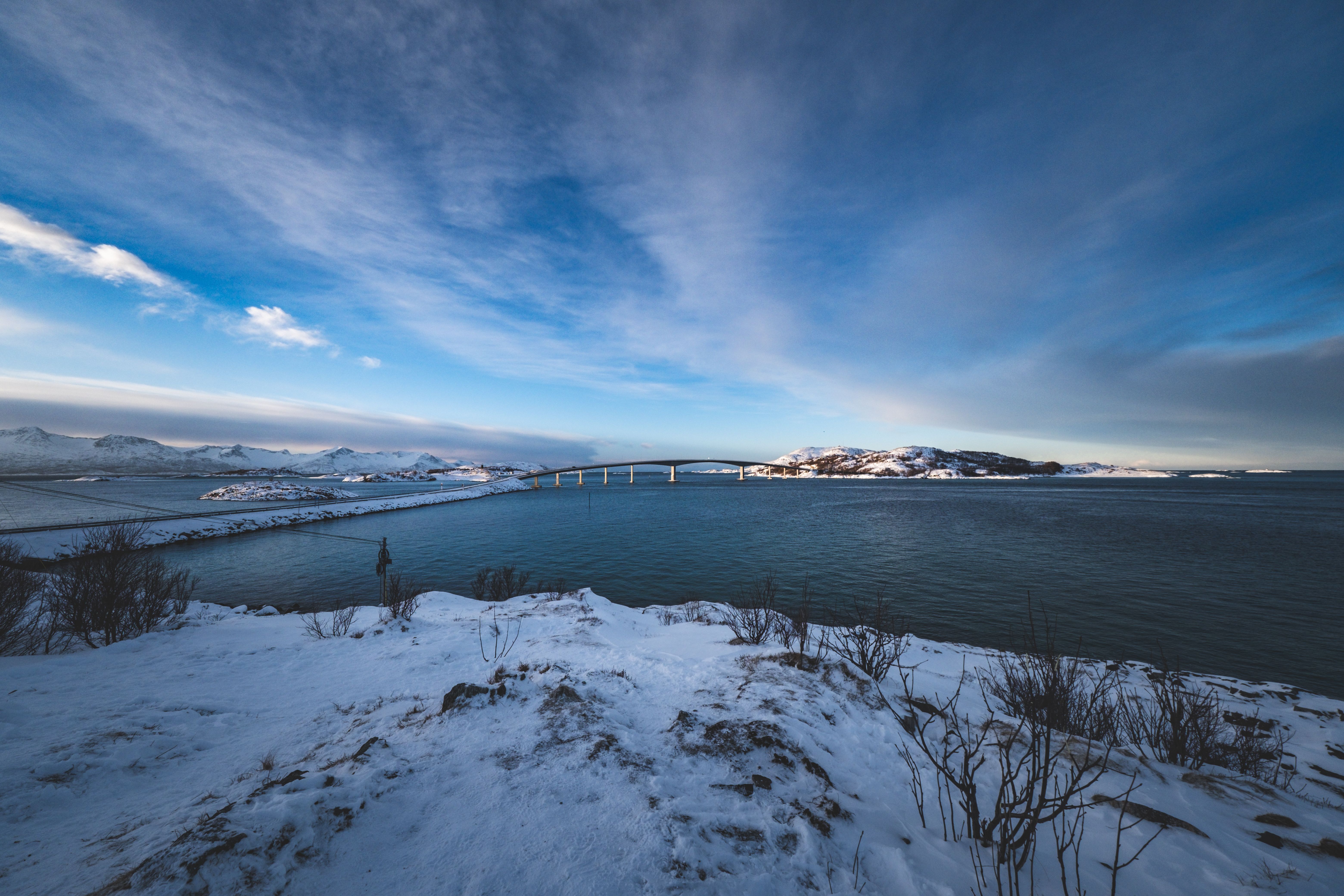 Snow on Sea Coast with Bridge behind in Norway · Free Stock Photo