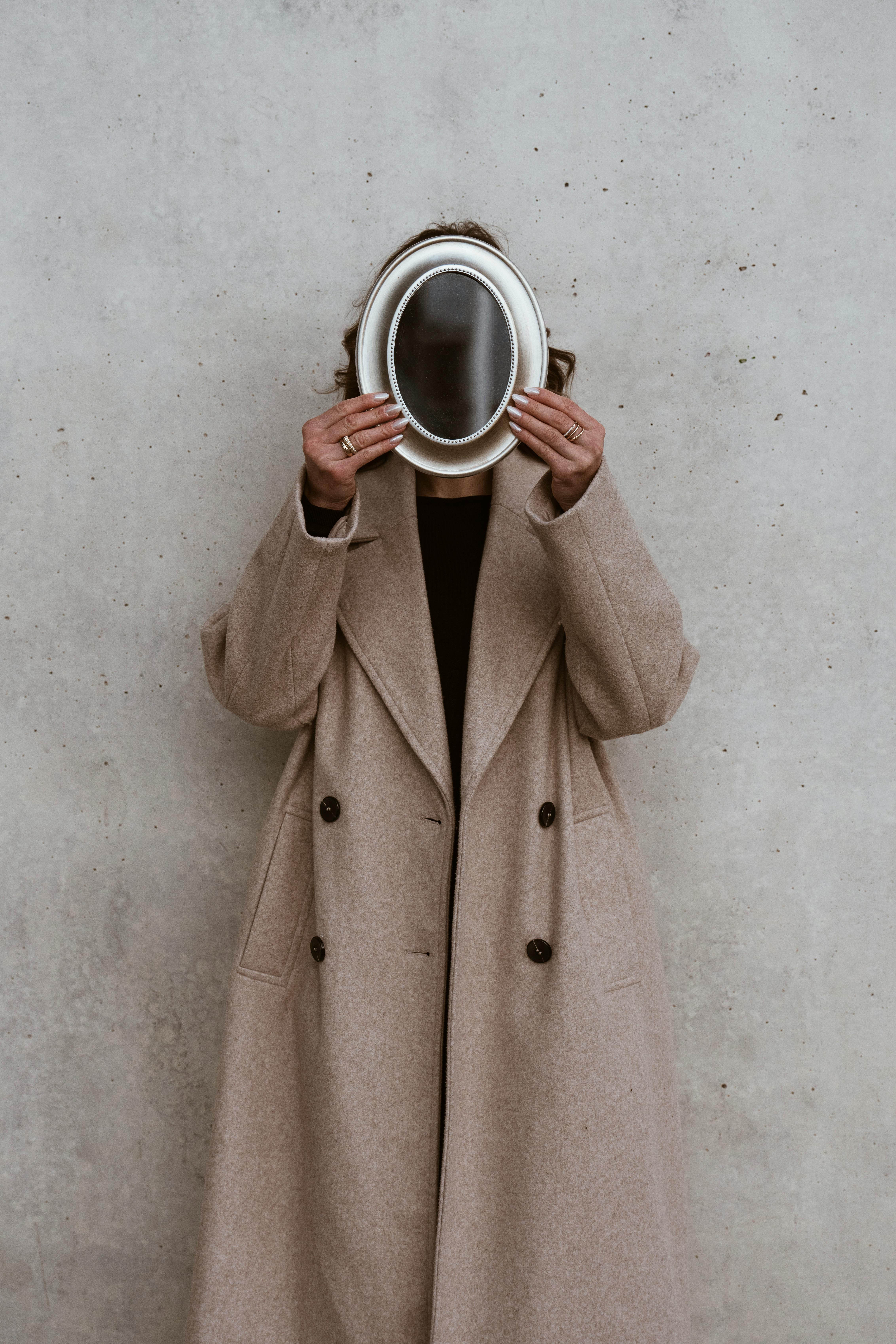 Woman Wearing Coat and Holding a Mirror · Free Stock Photo